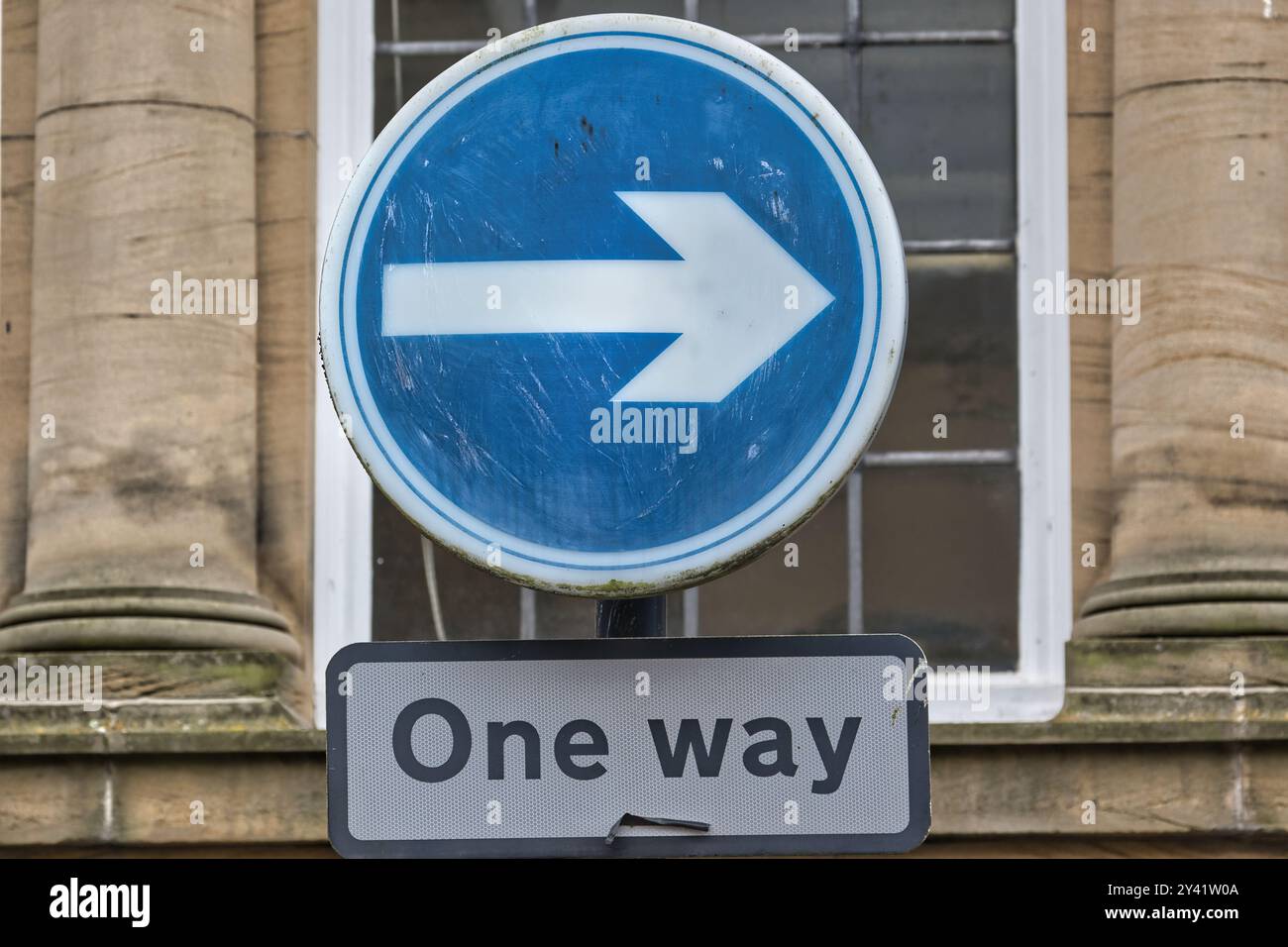 A circular blue road sign with a white right arrow, indicating one-way ...