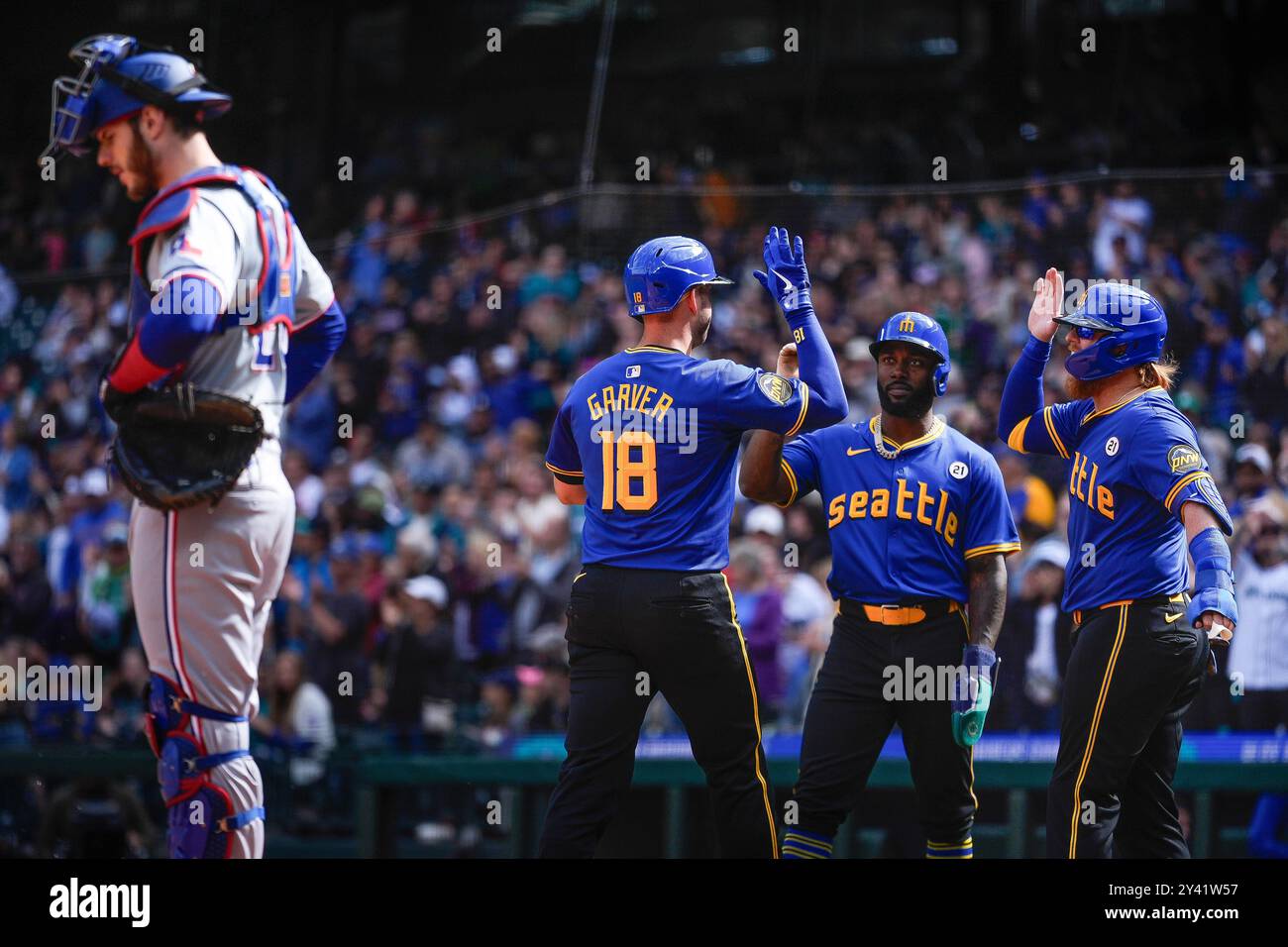 Seattle Mariners' Mitch Garver (18) greets teammates Randy Arozarena ...