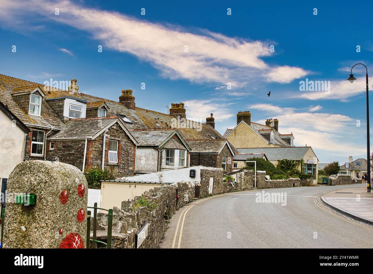 A picturesque street scene featuring charming houses with slate roofs ...