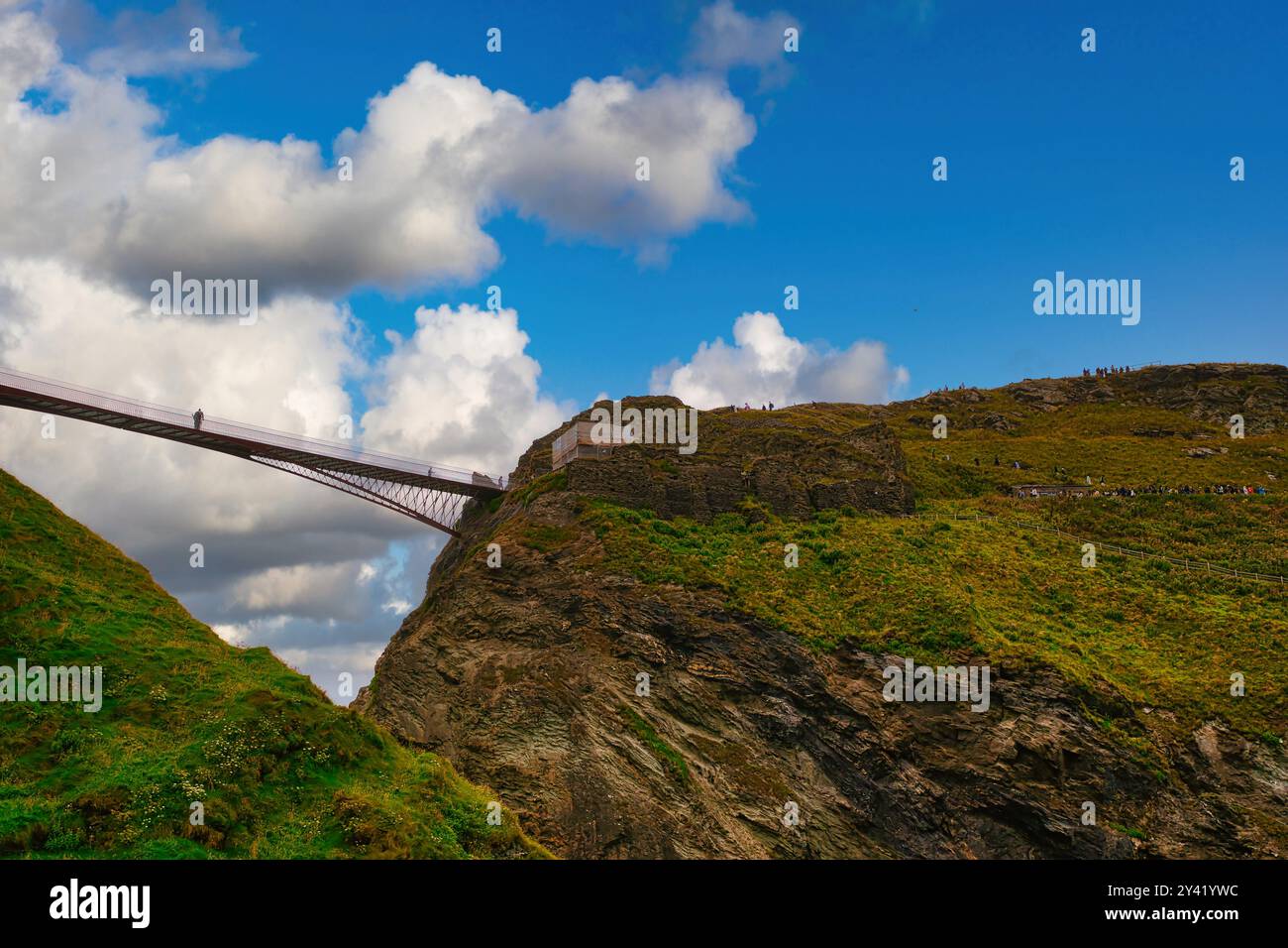 A scenic view of a bridge connecting two cliffs, surrounded by lush ...