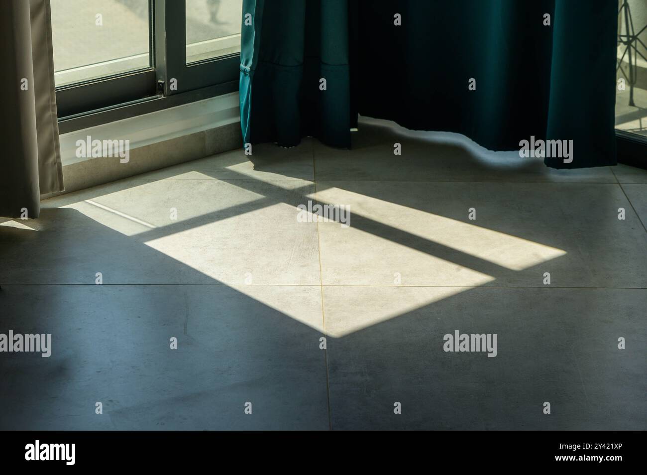 Sunlight pours through panoramic window in modern empty living room of ...