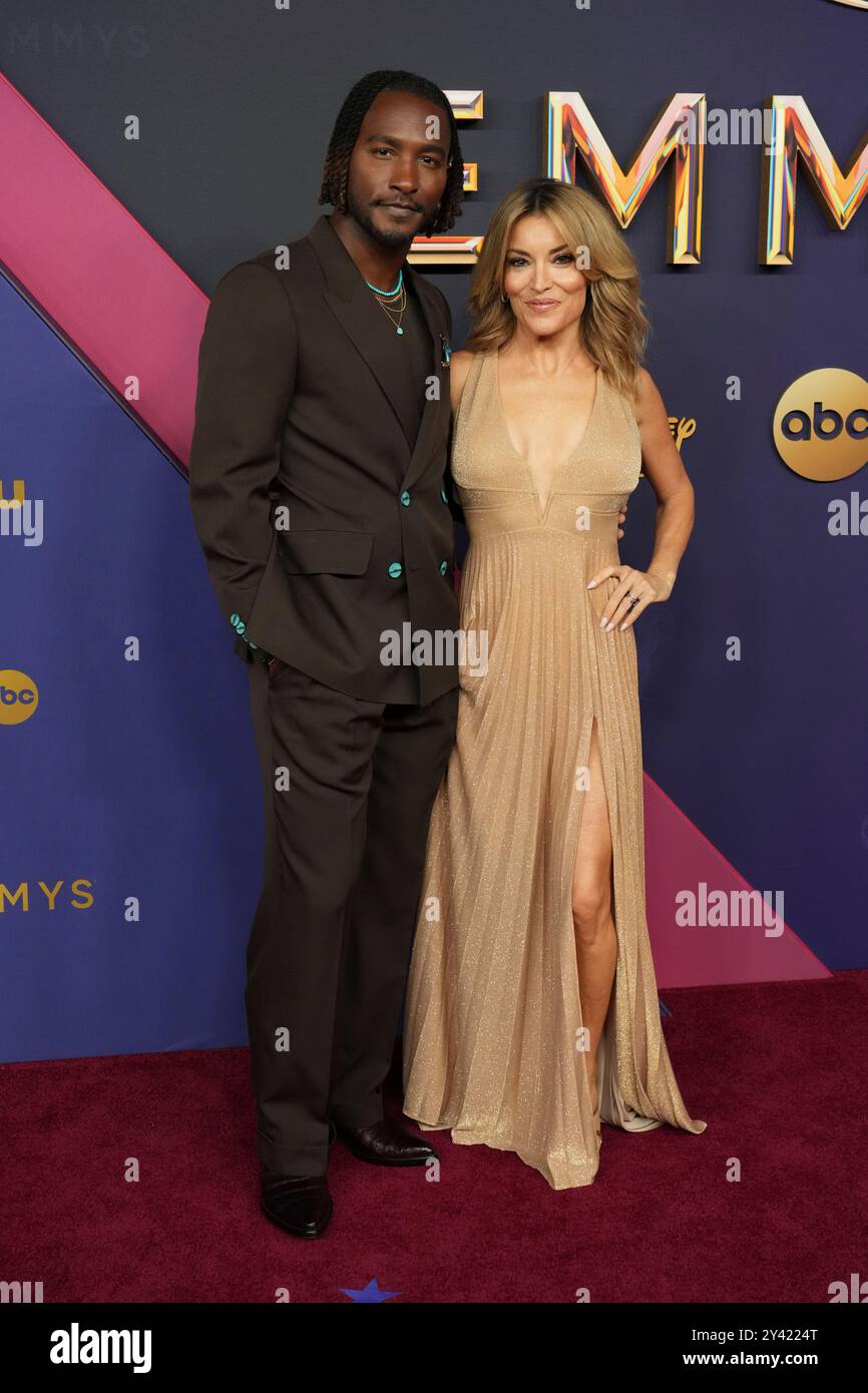 Scott Evans and Kit Hoover pose for a Red Carpet portrait at the 76th ...