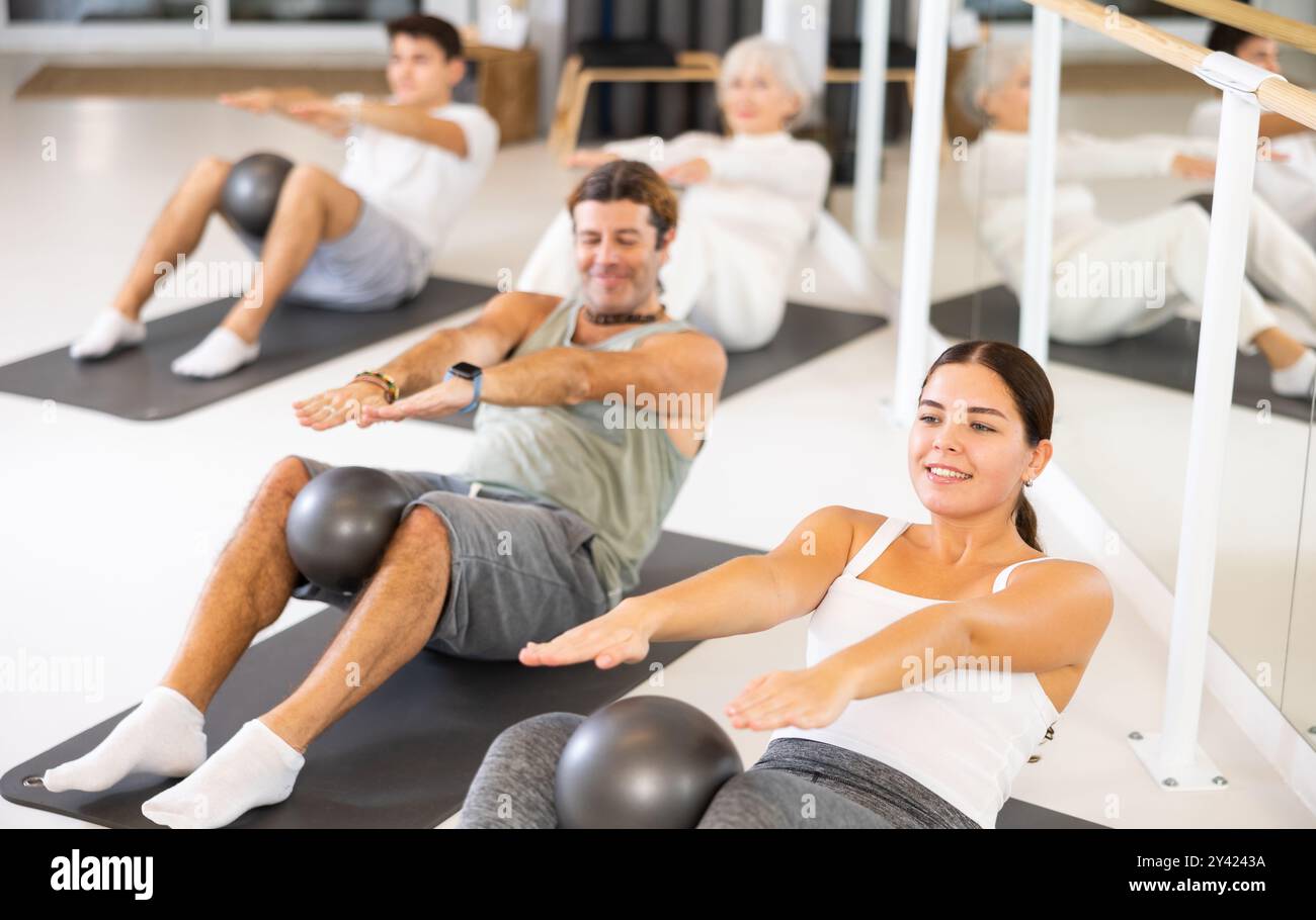 Group of different people doing exercises with ball Stock Photo - Alamy