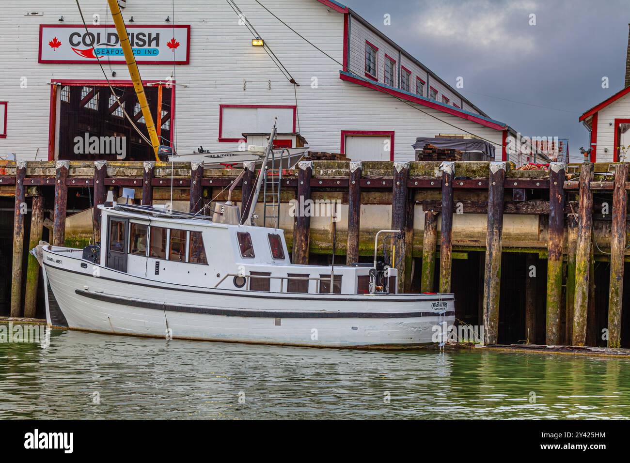 Small fishing vessel tied up at a fish processing facility in Steveston ...