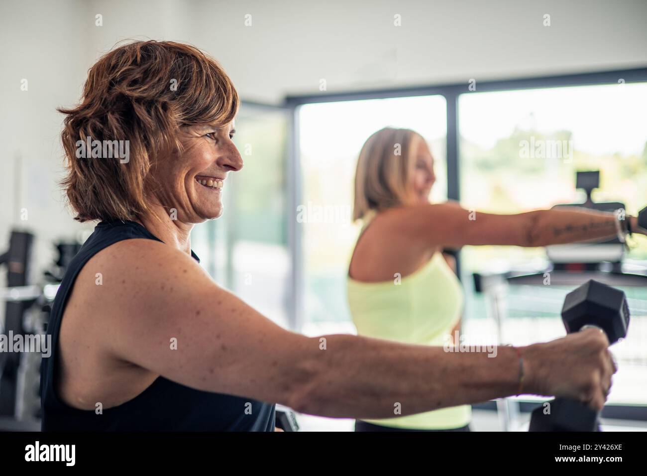 Elderly women practice arm exercises hi-res stock photography and ...