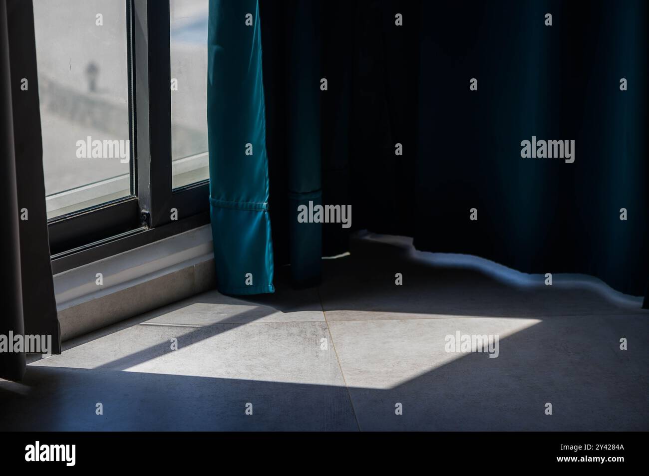 Sunlight pours through panoramic window in modern empty living room of ...