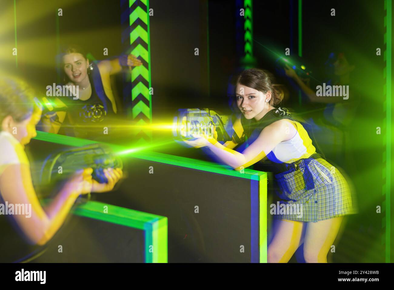 Laser tag players cheerful positive smiling girls playing in teams in ...