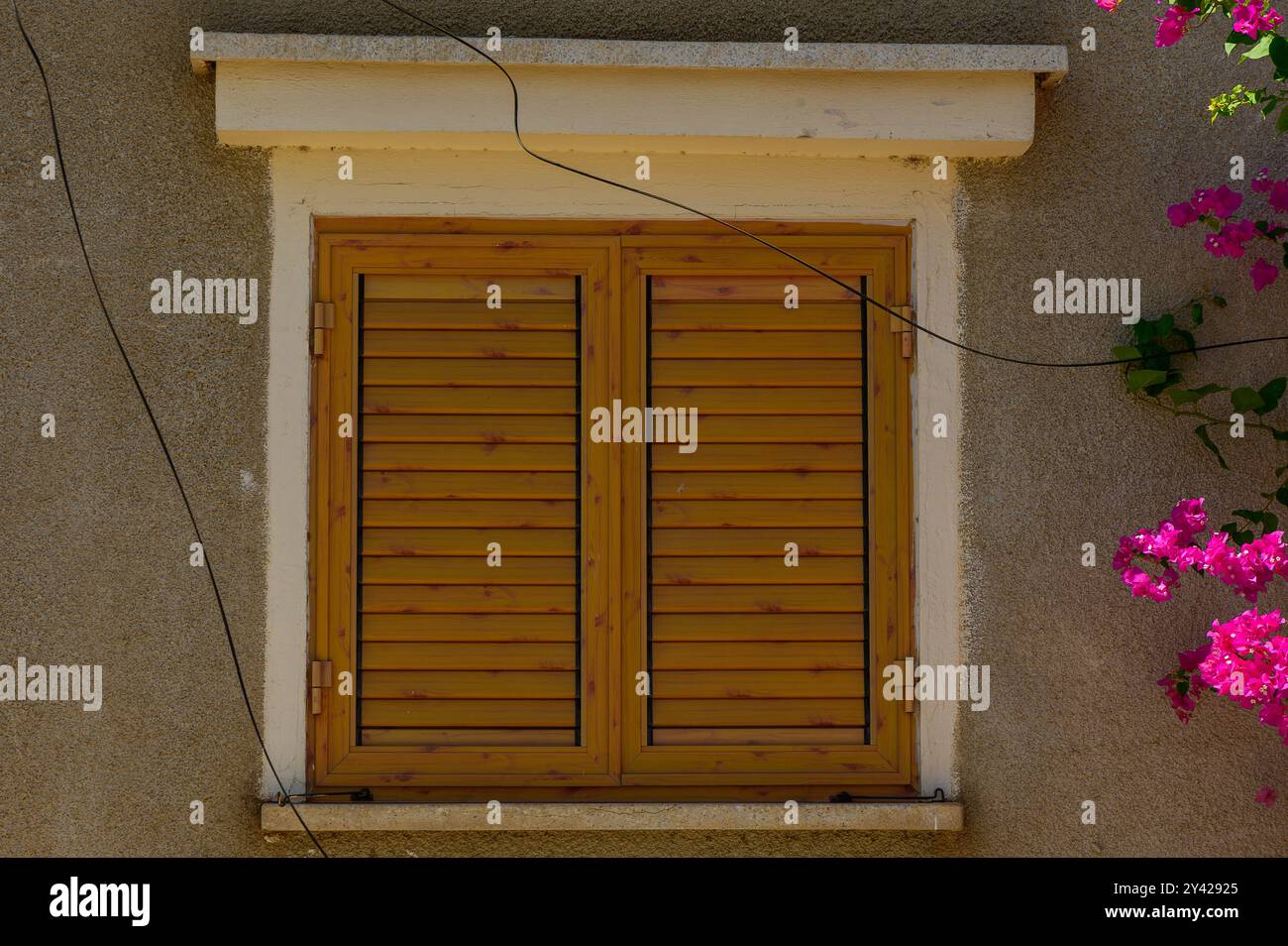 window covered with brown wooden shutters on the wall of boards Stock ...