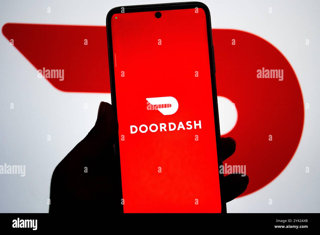 In this photo illustration, a Doordash logo seen displayed on a ...