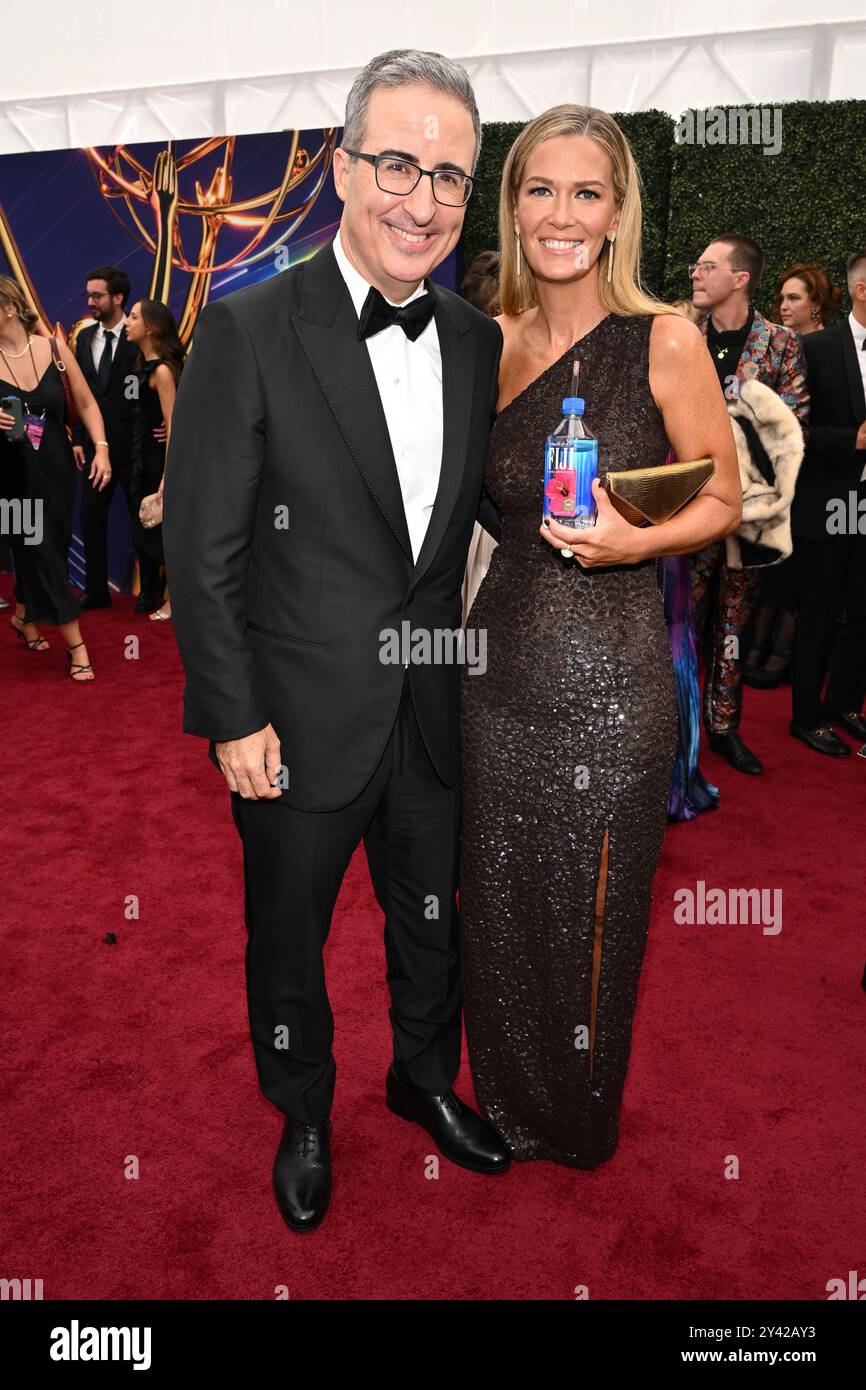 John Oliver, left, and Kate Norley arrive at the 76th Emmy Awards with ...