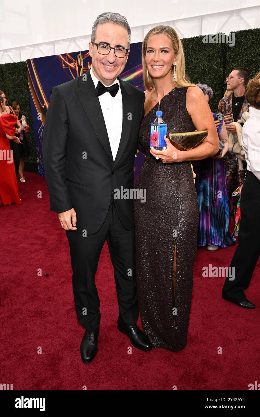 John Oliver, left, and Kate Norley arrive at the 76th Emmy Awards with ...