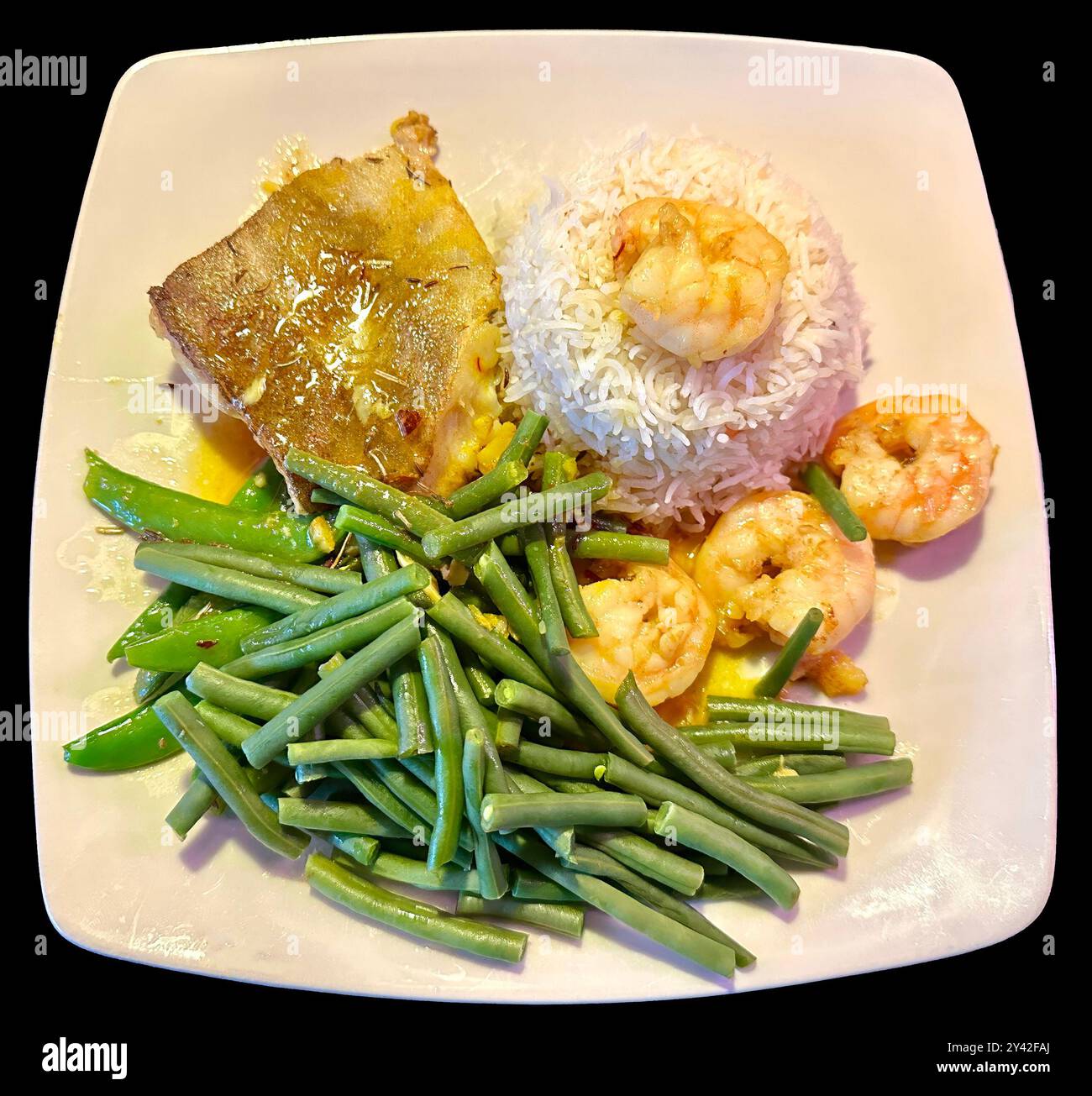 Delicious plate of fresh caught cod fish with prawns in garlic butter ...