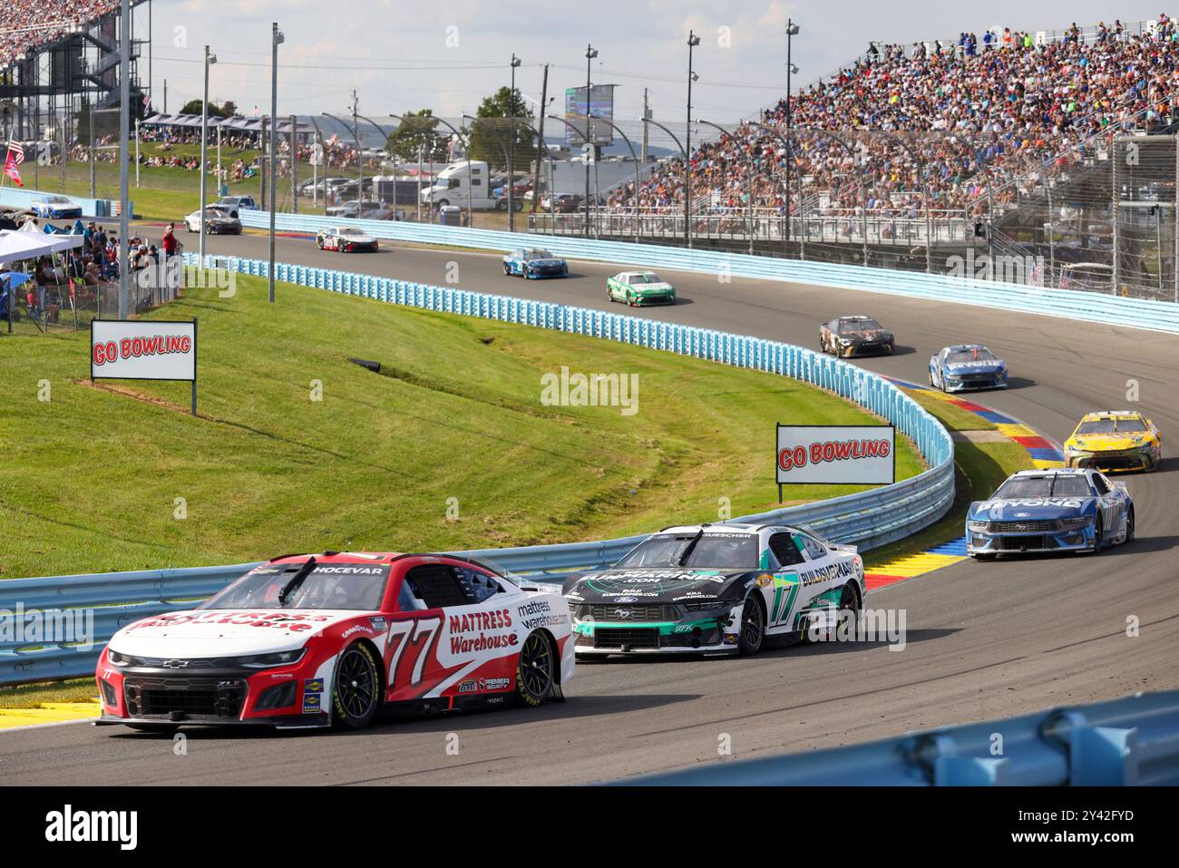 Carson Hocevar (77) is followed by Chris Buescher (17) during a NASCAR ...