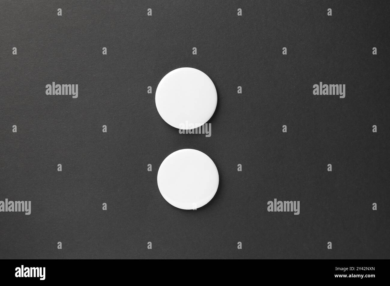 Blank white button badges on black background, top view. Mockup for ...