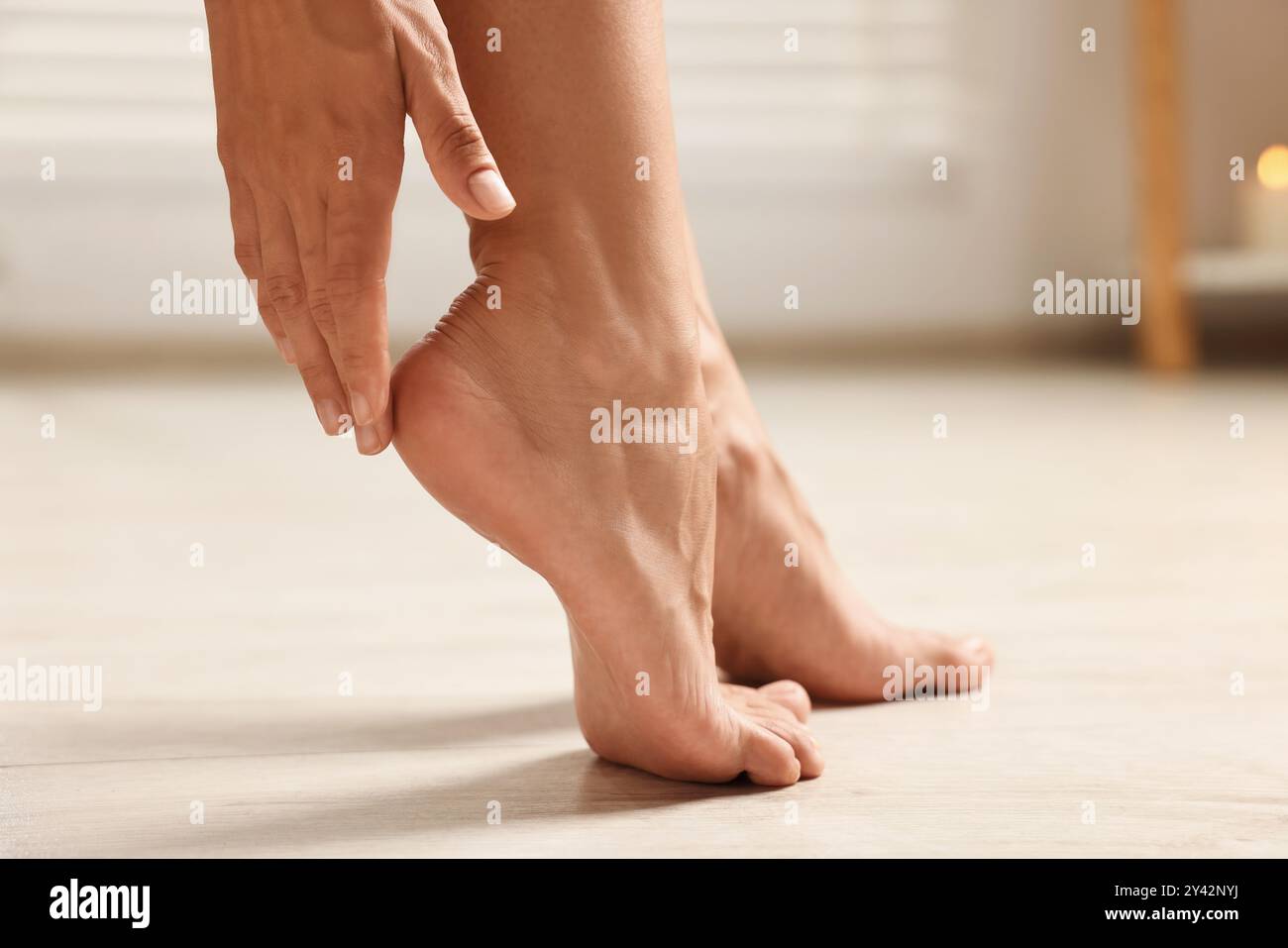 Woman touching her smooth feet on floor, closeup. Body care Stock Photo ...