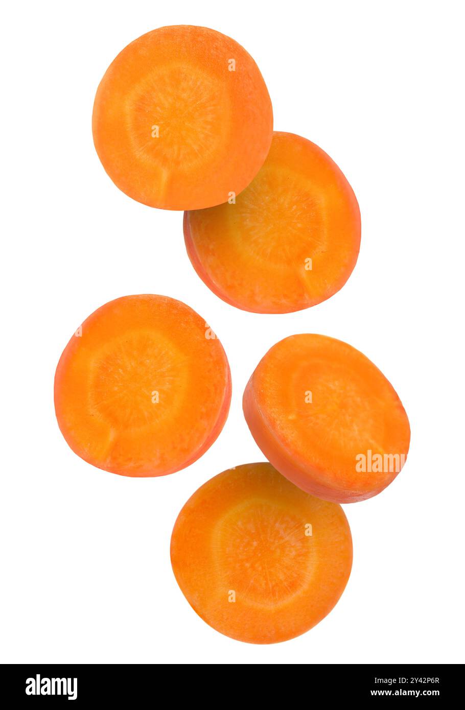 Round carrot slices in air on white background Stock Photo - Alamy