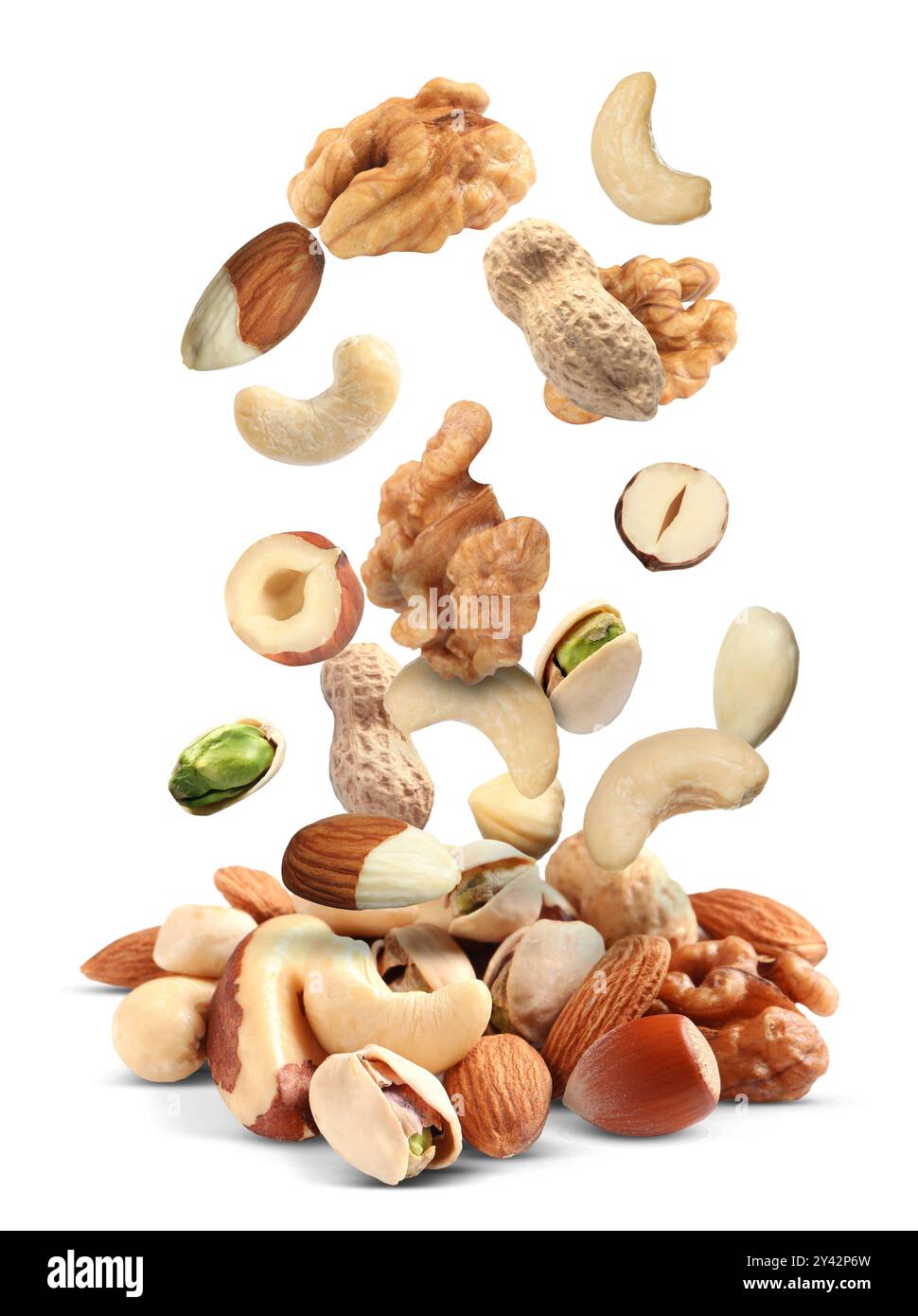Mix of nuts falling on white background Stock Photo - Alamy
