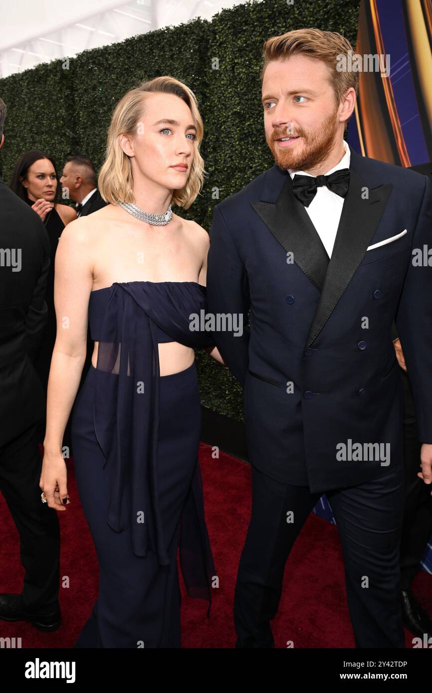 Saoirse Ronan, left, and Jack Lowden walk the Red Carpet at the 76th ...