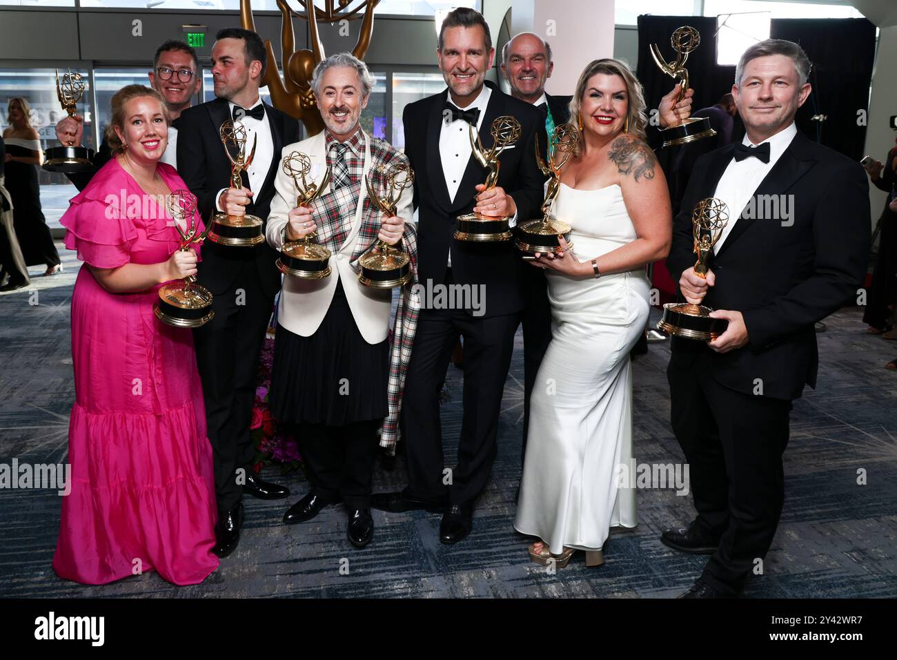 The team from "The Traitors" pick up their official Emmy statuette for ...