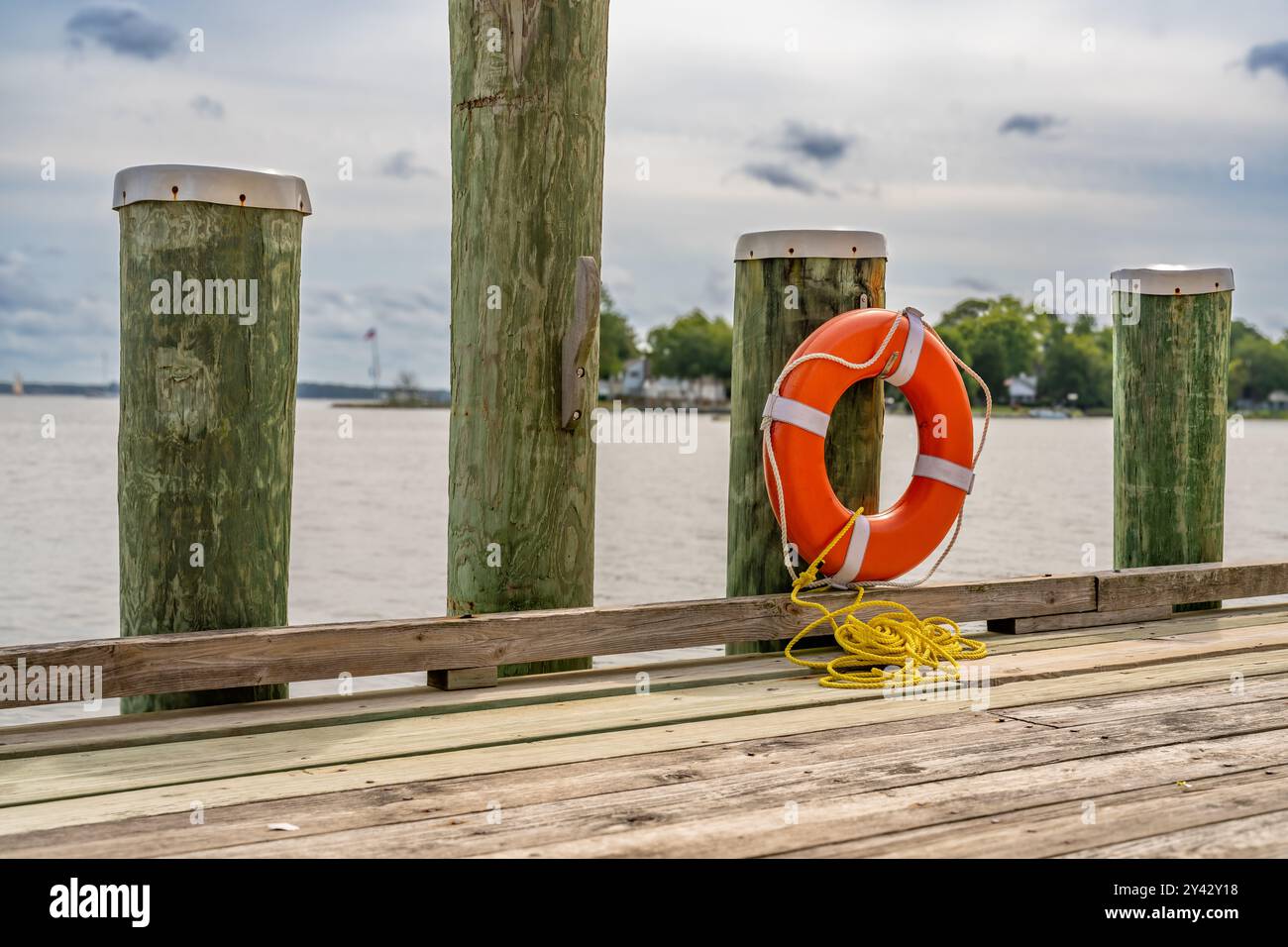 Orange lifesaver ring, harbor life preserver, mounted on a dock's pile ...