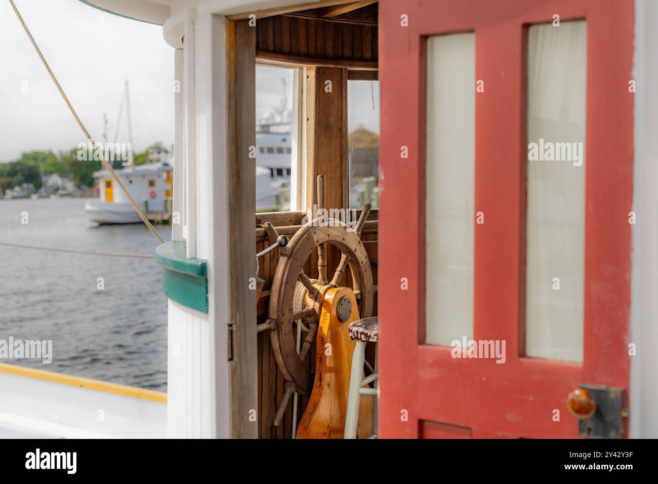 Close-up photo of a boats wheel house, wheel, while docked in port ...
