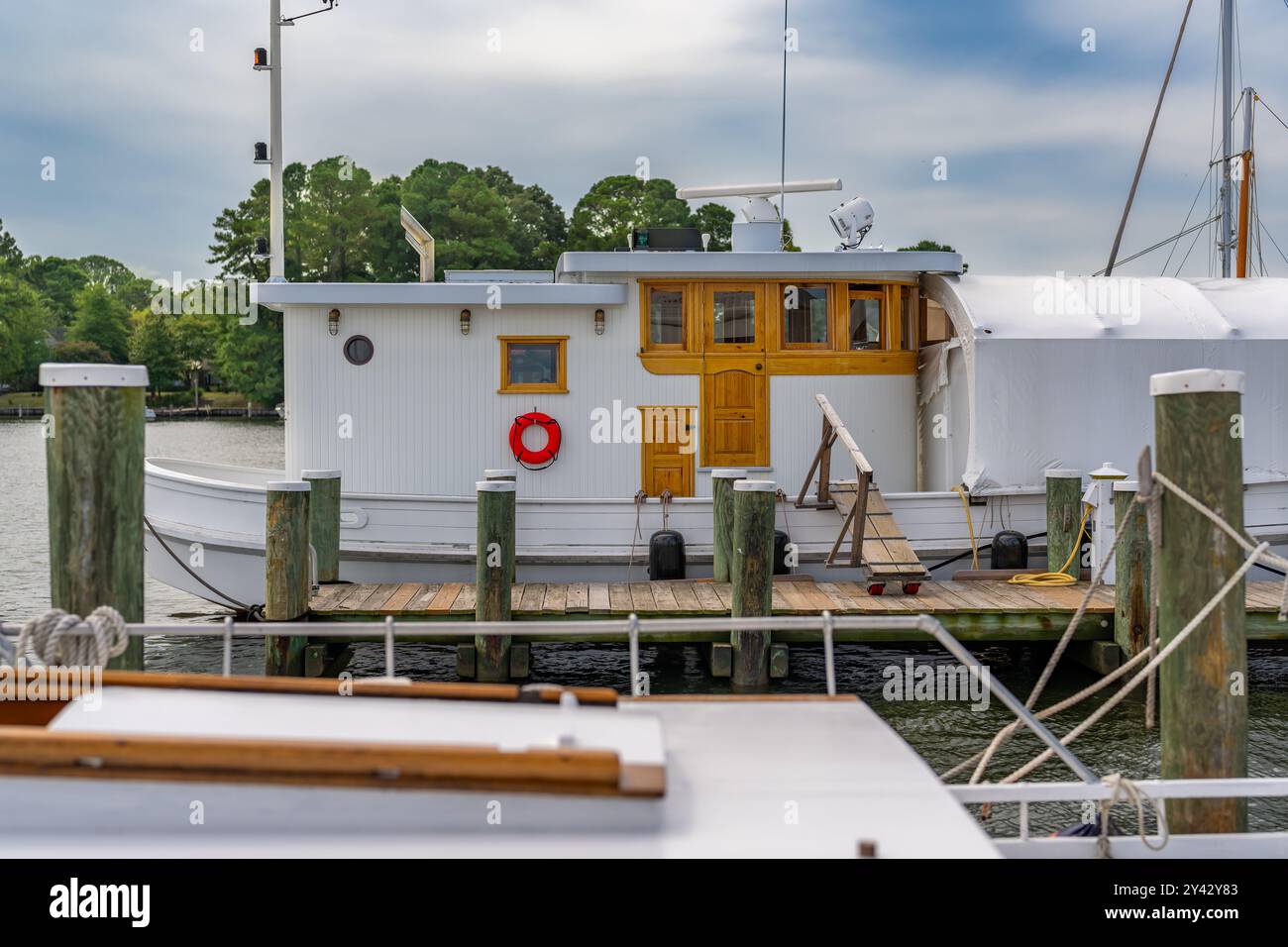 Close-up photo the front end of a non-descript wooden boat while docked ...