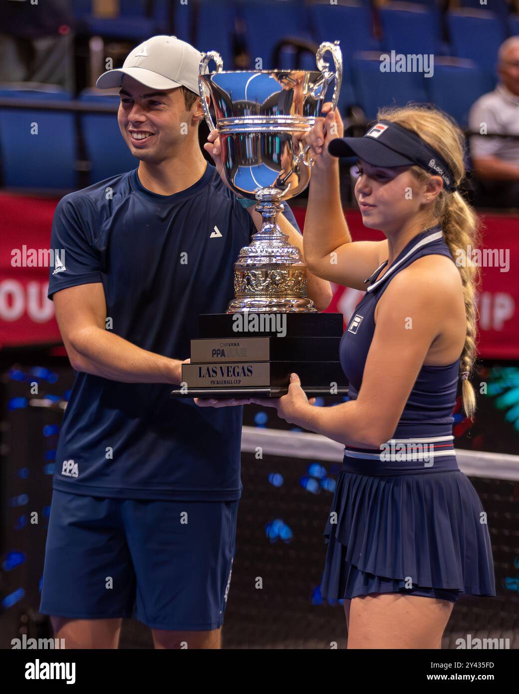 Ben Johns and Anna Leigh Waters hod the Championship Trophy for winning ...