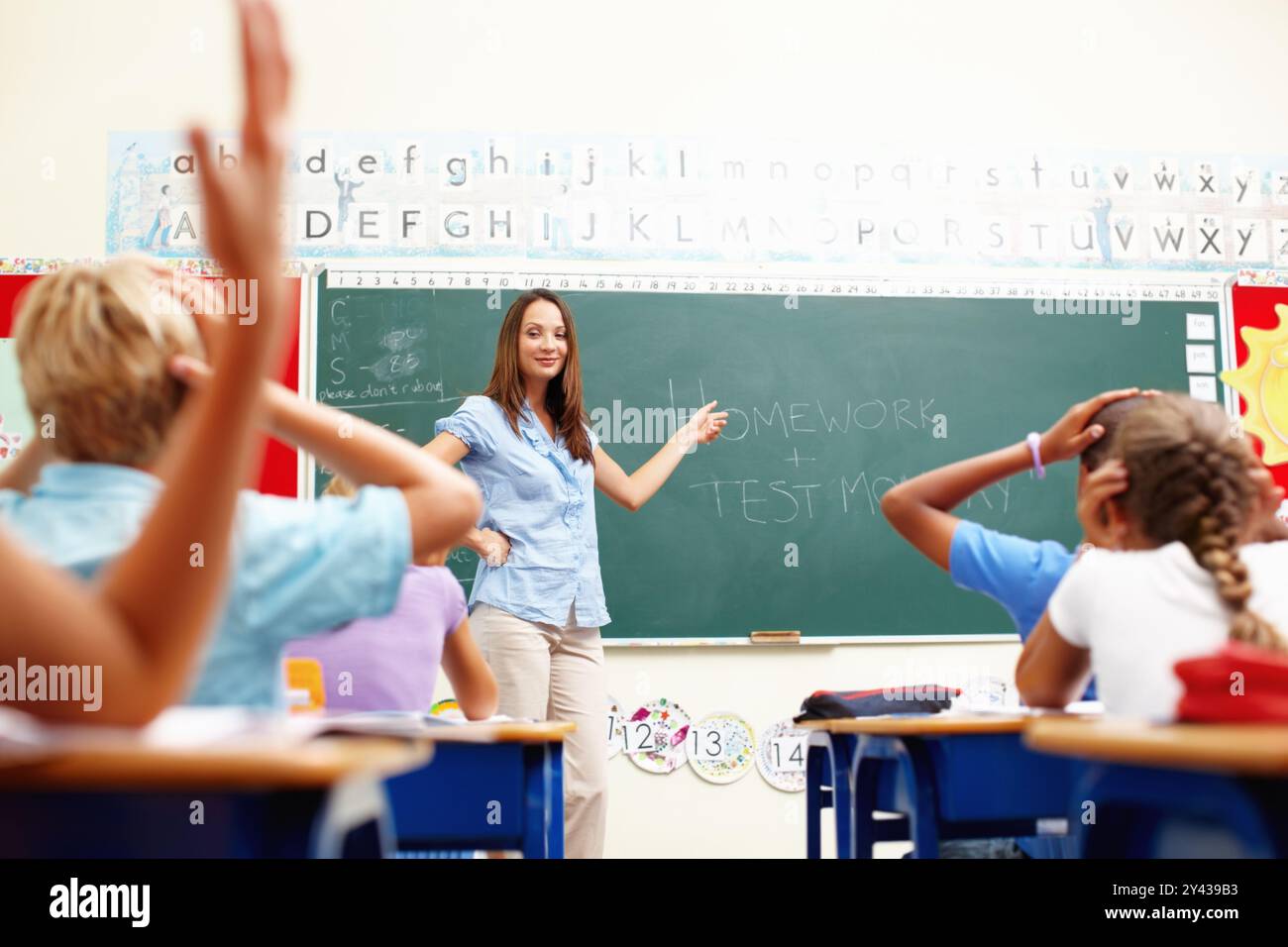 Chalkboard, teaching and woman in kids classroom for learning, growth ...