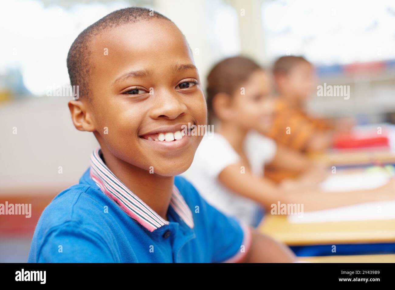 Smile, portrait and boy in classroom for writing test, growth and child ...