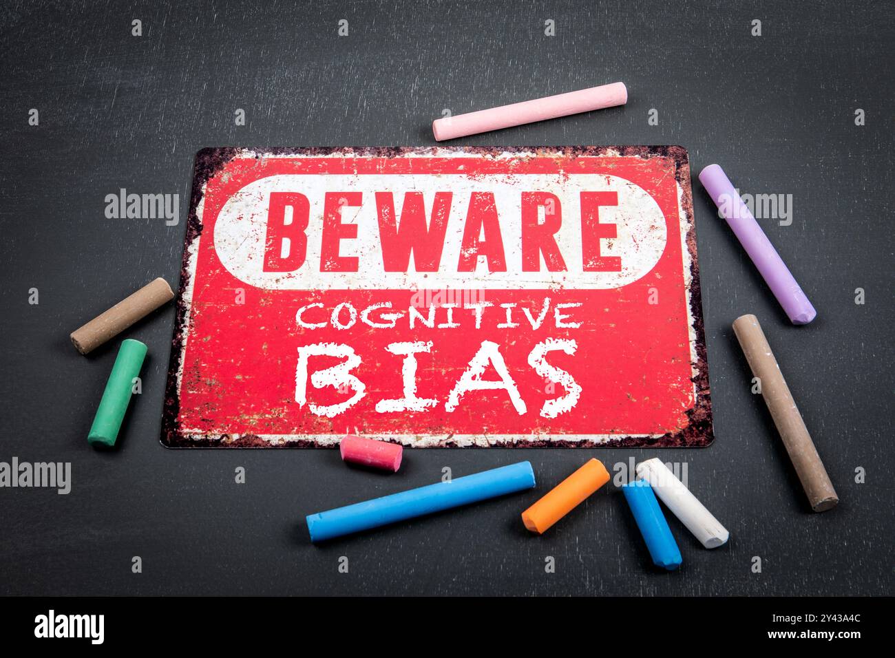 Cognitive Bias. Beware sign with text and colored pieces of chalk on a ...