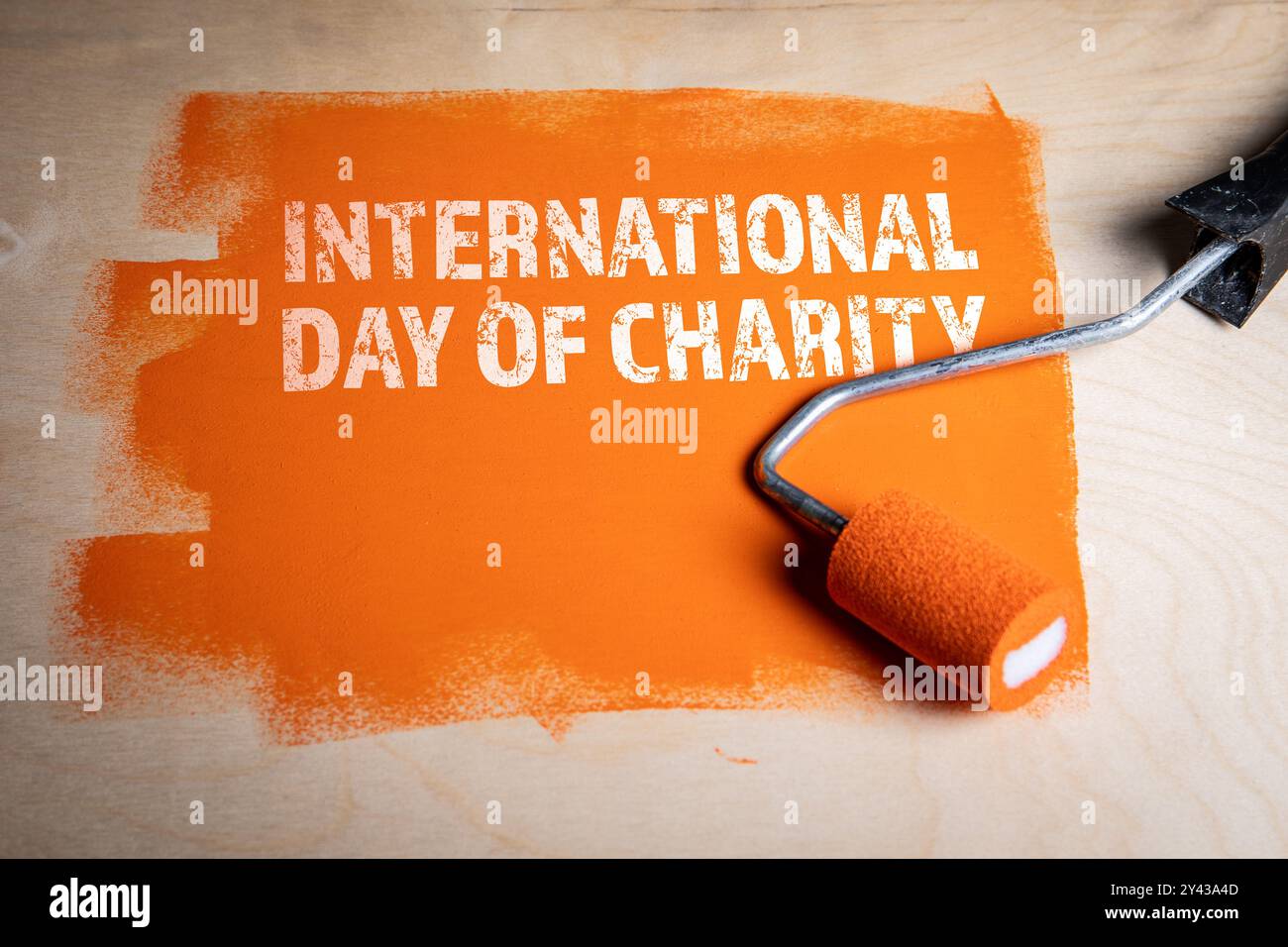 International Day of Charity, 5 September. Orange color on wood texture ...