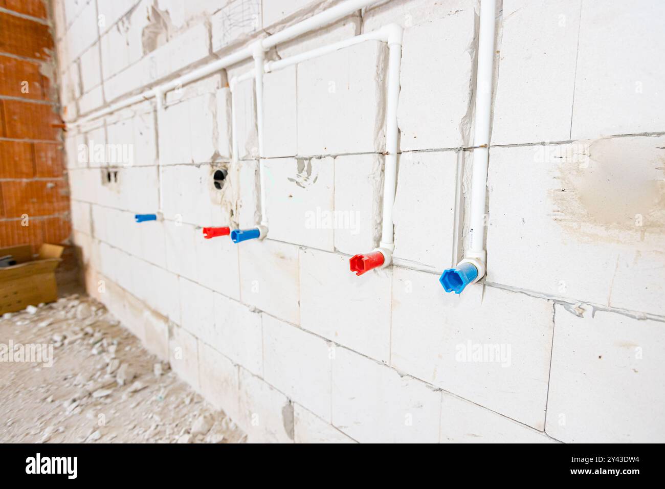 New unfinished plumbing installation exposed white PVC pipes mounted in ...