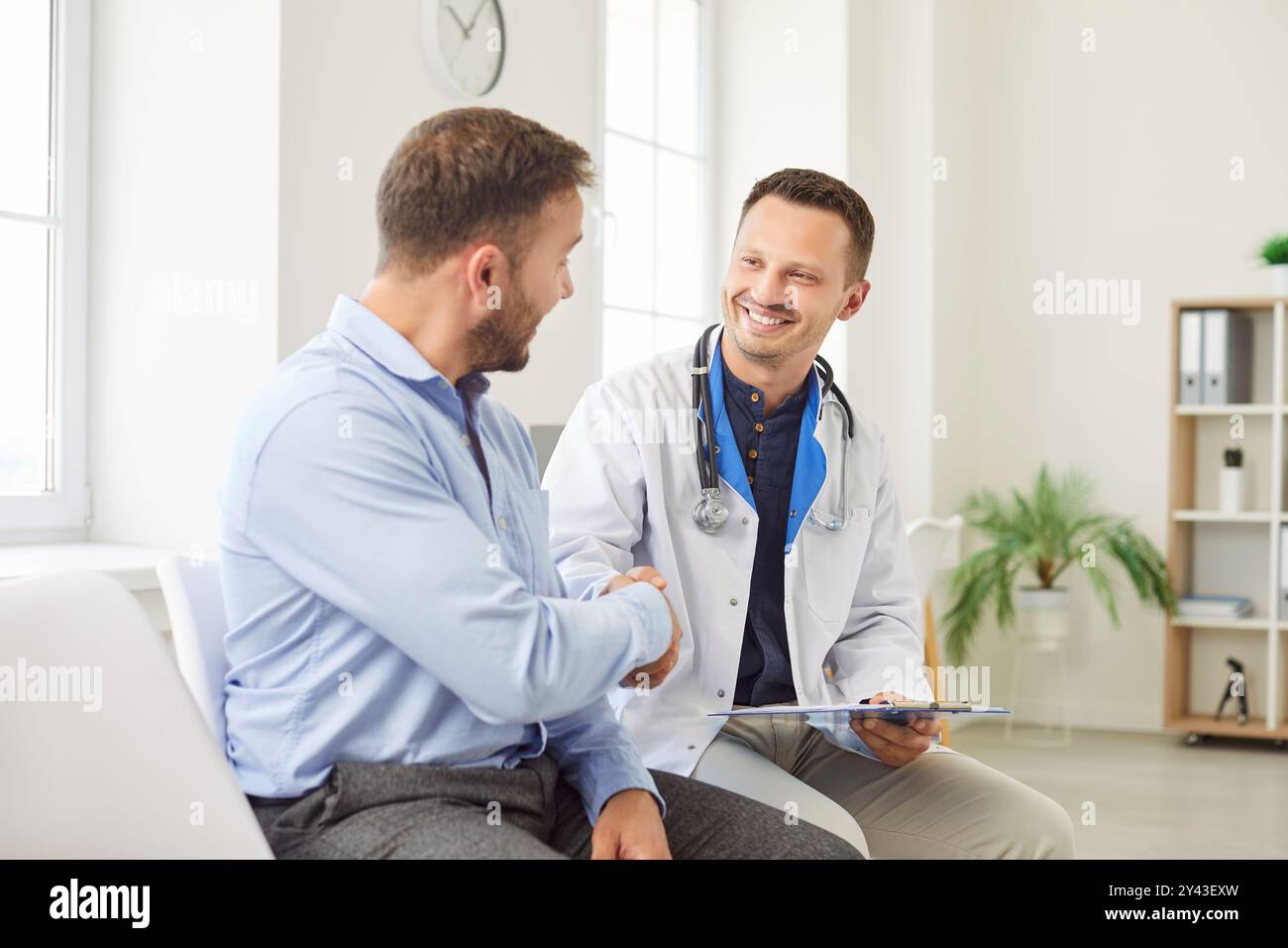 Doctor or Nurse Shaking Hands with Male Patient During Hospital Visit ...