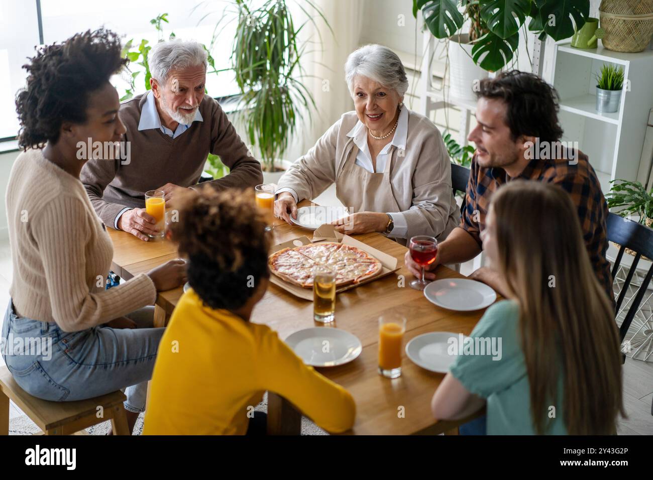 Multiethnic, three generation family together celebration with parents ...