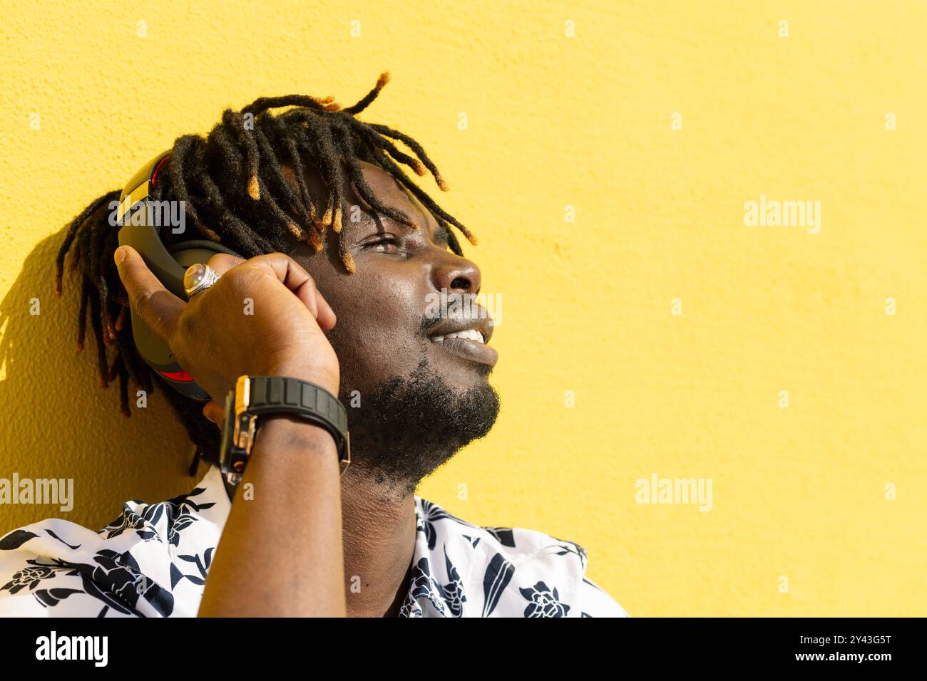 Positive african man listening music hi-res stock photography and ...