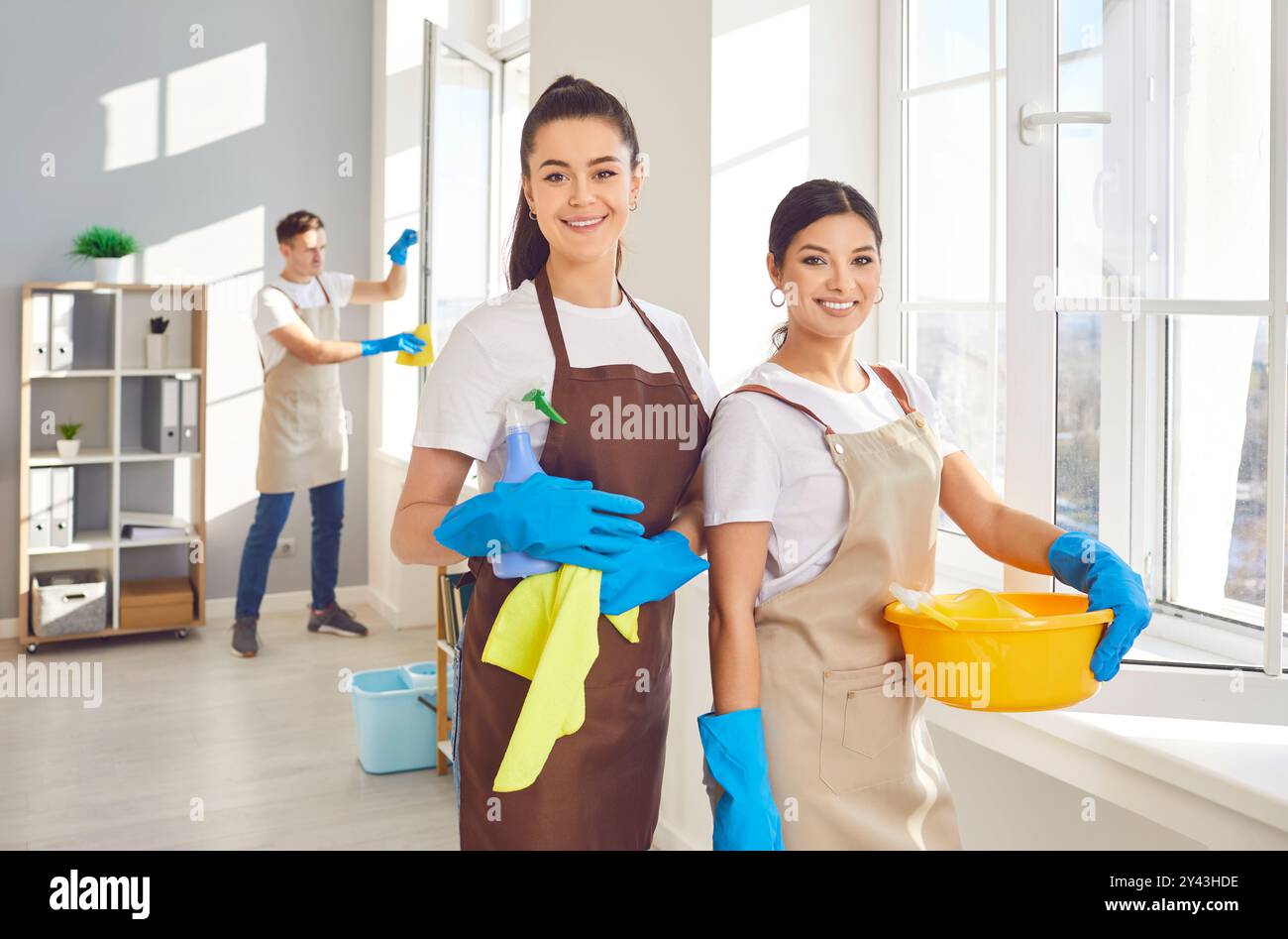 Cleaning company diligently cleans up room two women posing with smiles ...