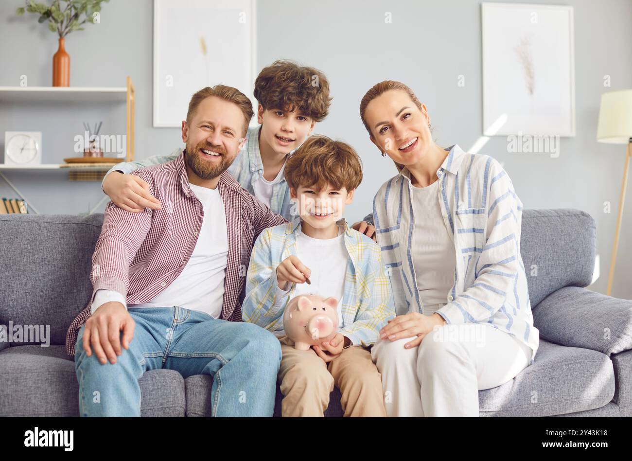 Happy smiling family at home, parents teaching saving money budget ...