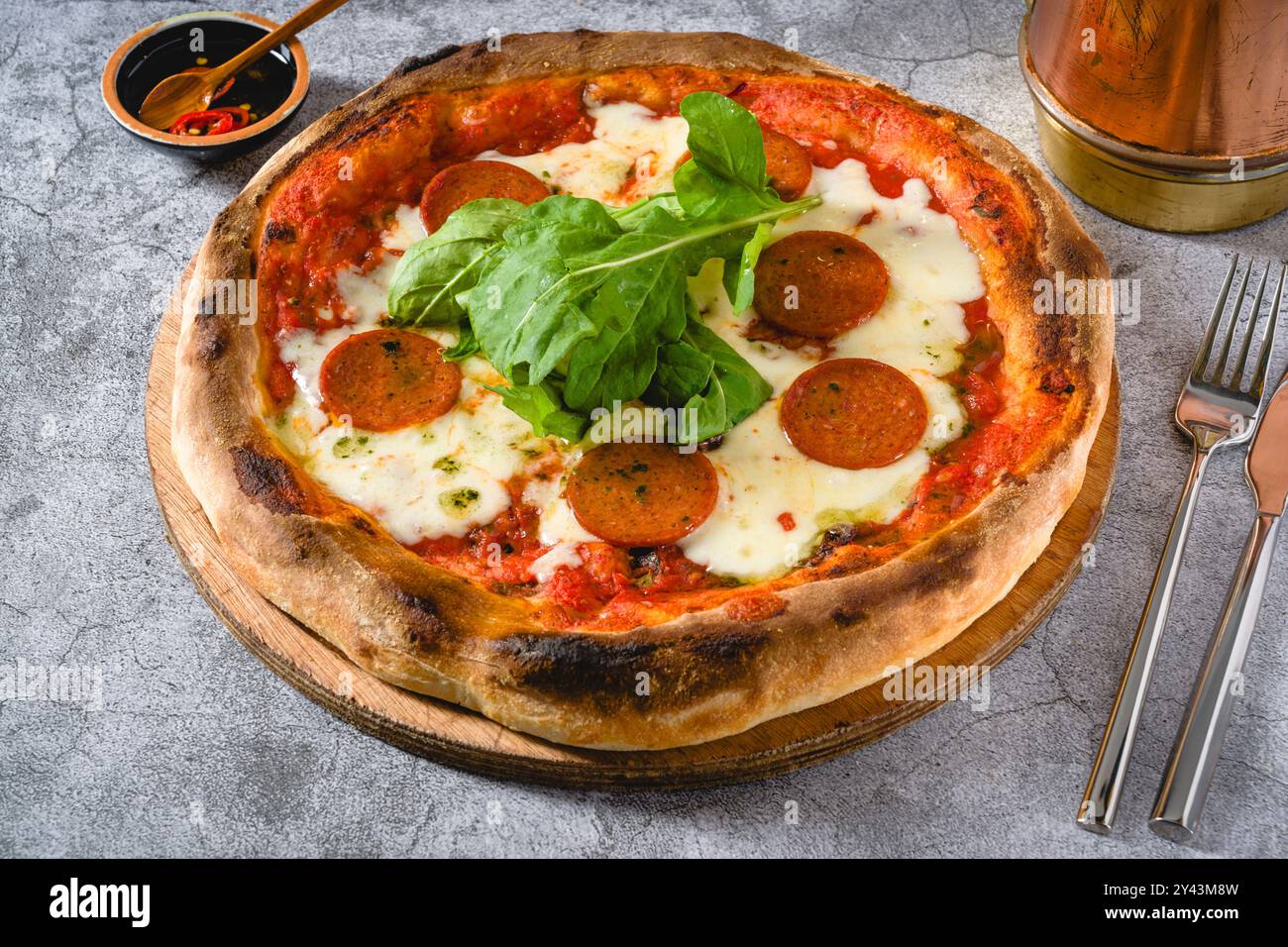 Top view of Neapolitan pizza with sausage, jalapeno peppers and arugula ...