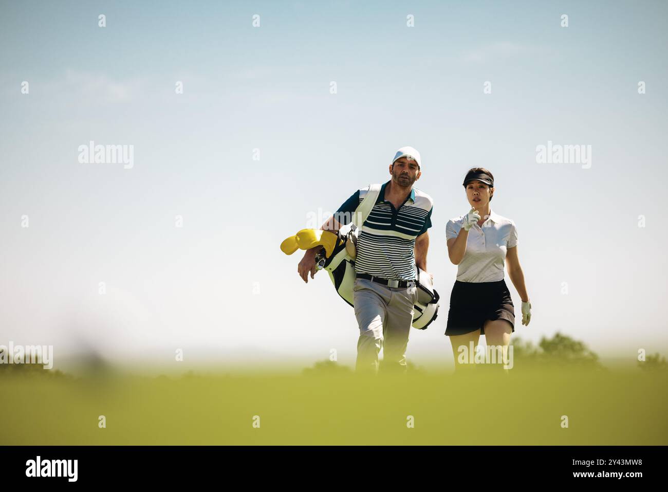 A sportswoman and her golf instructor engage in planning strategy ...