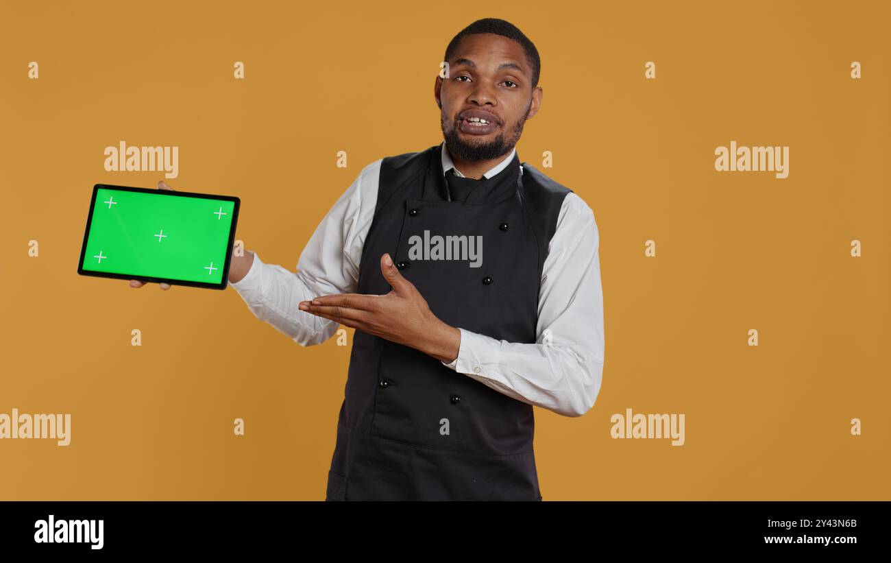 Catering employee presenting an isolated chroma key display while he ...