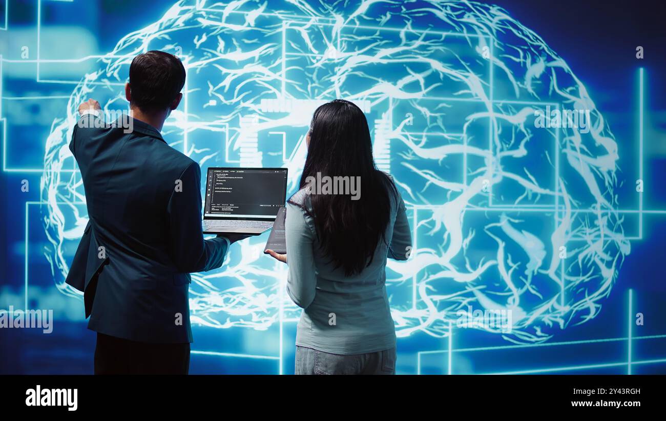 Coworkers doing brainstorming, using devices to fix artificial intelligence neural networks ...