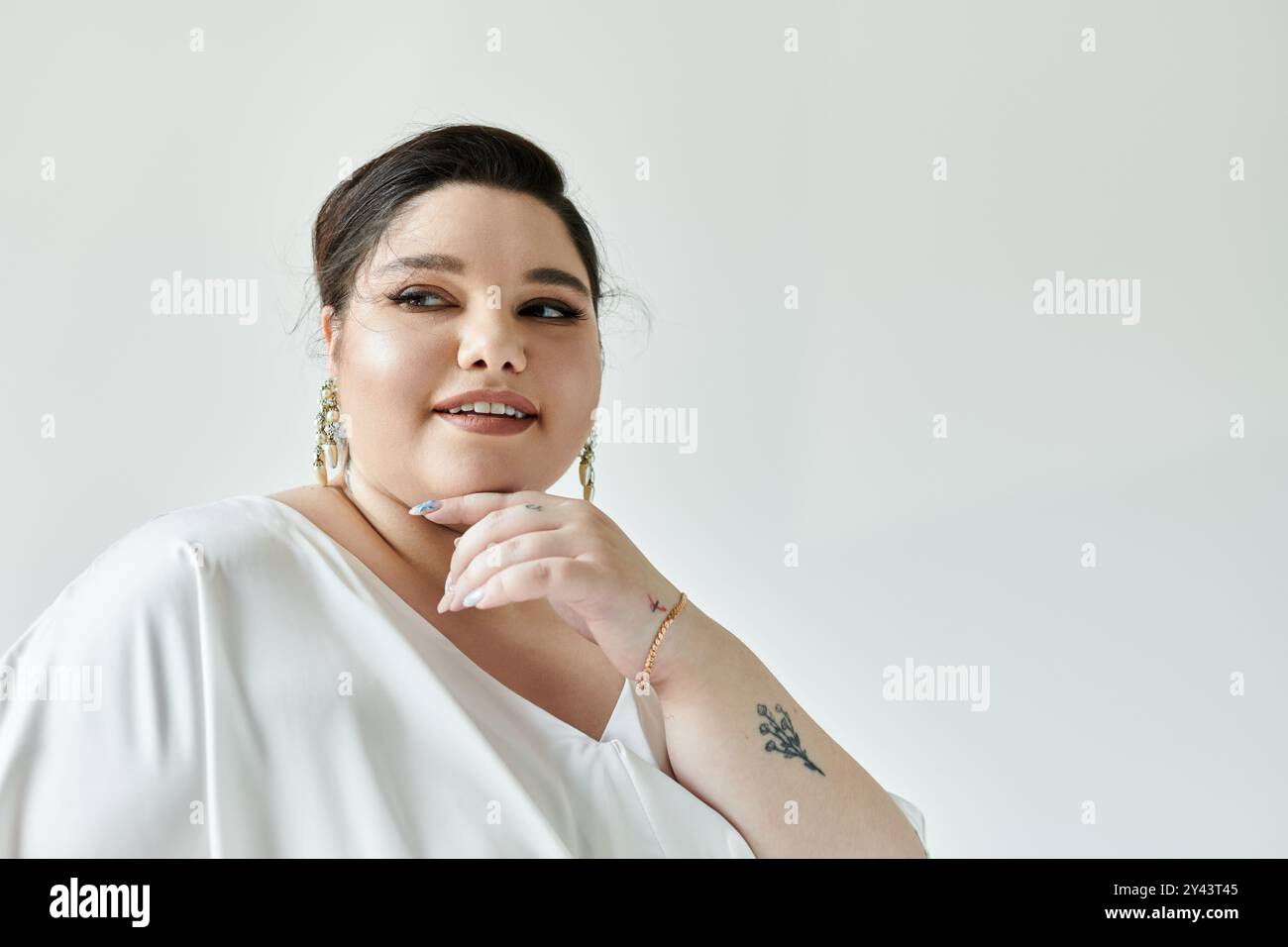 A stunning plus size bride exudes confidence and grace in her white ...