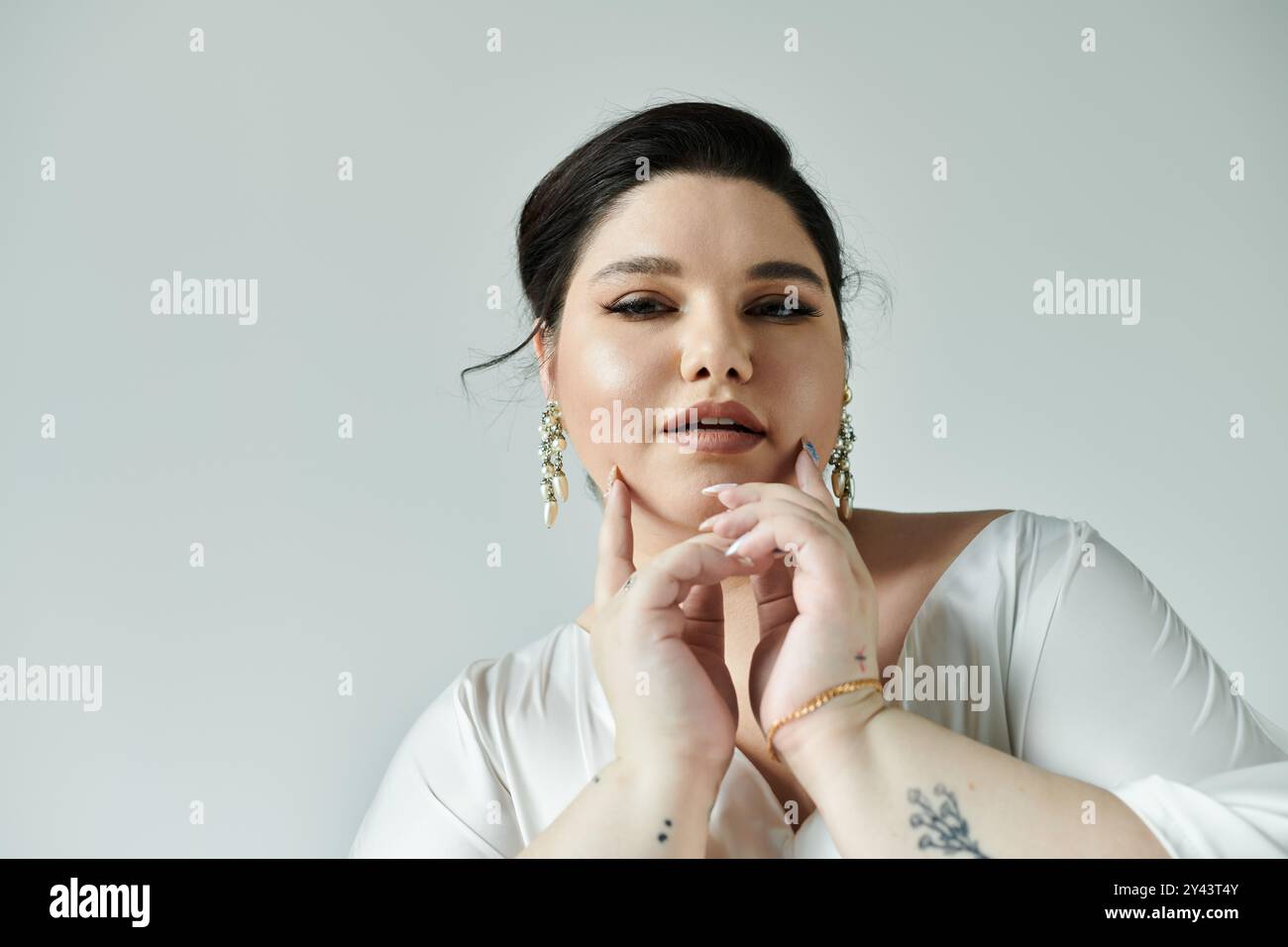 A beautiful plus size bride in a flowing white dress exudes confidence ...