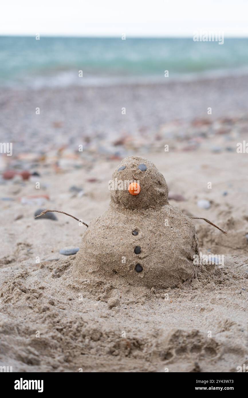 Snowman made with beach sand with copy space Stock Photo - Alamy