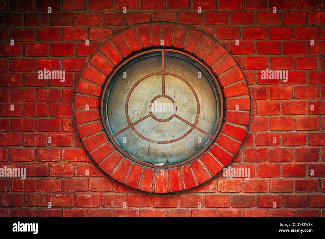 Round window, circular shaped window on a brick wall as background ...