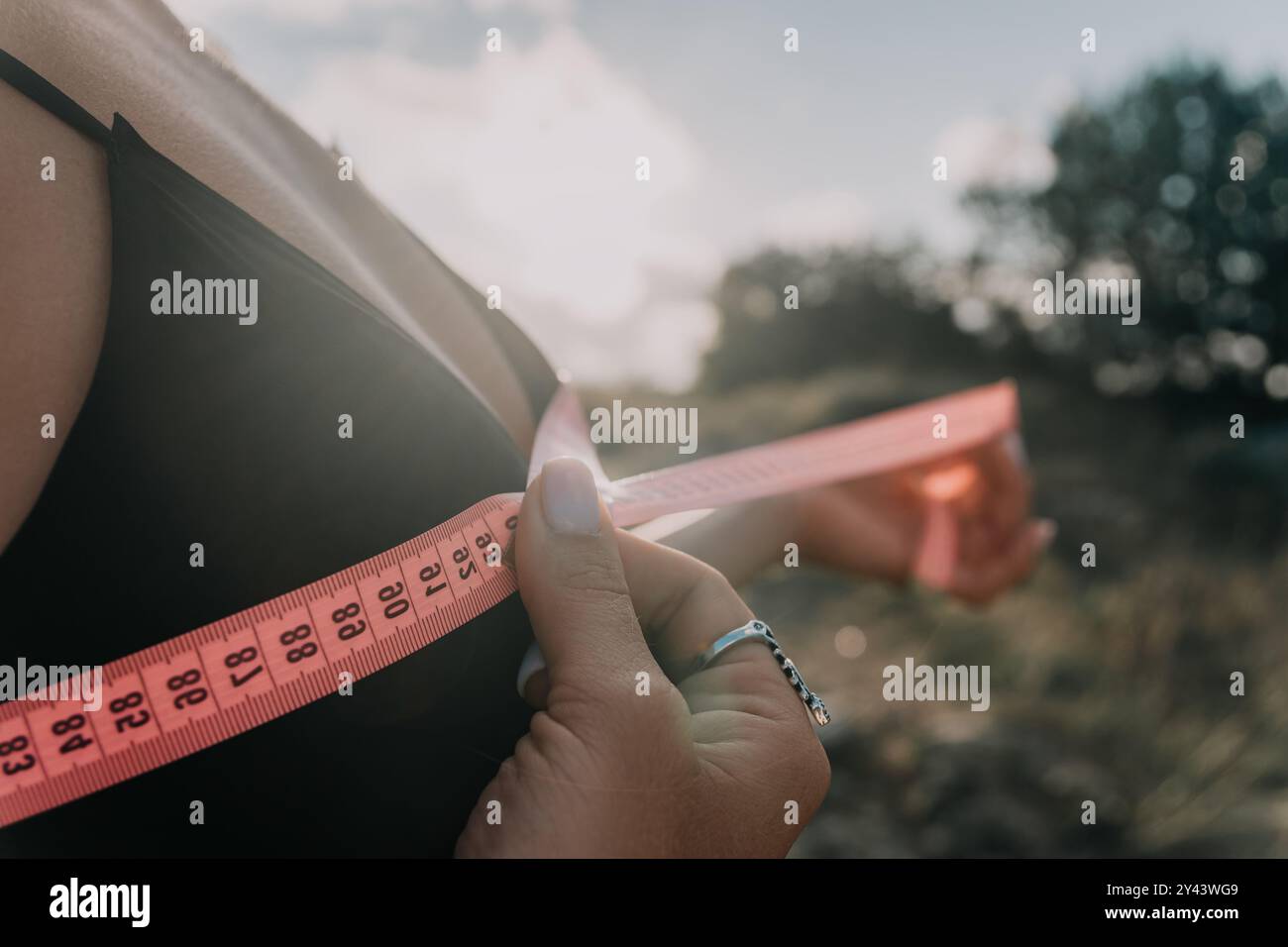Woman Measuring Chest with Tape Measure Outdoors for Body Measurement ...