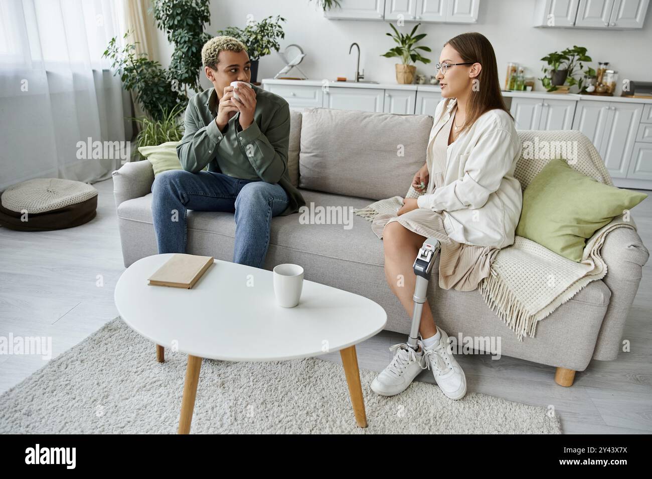 Two friends share a warm moment in a comfortable living room Stock ...