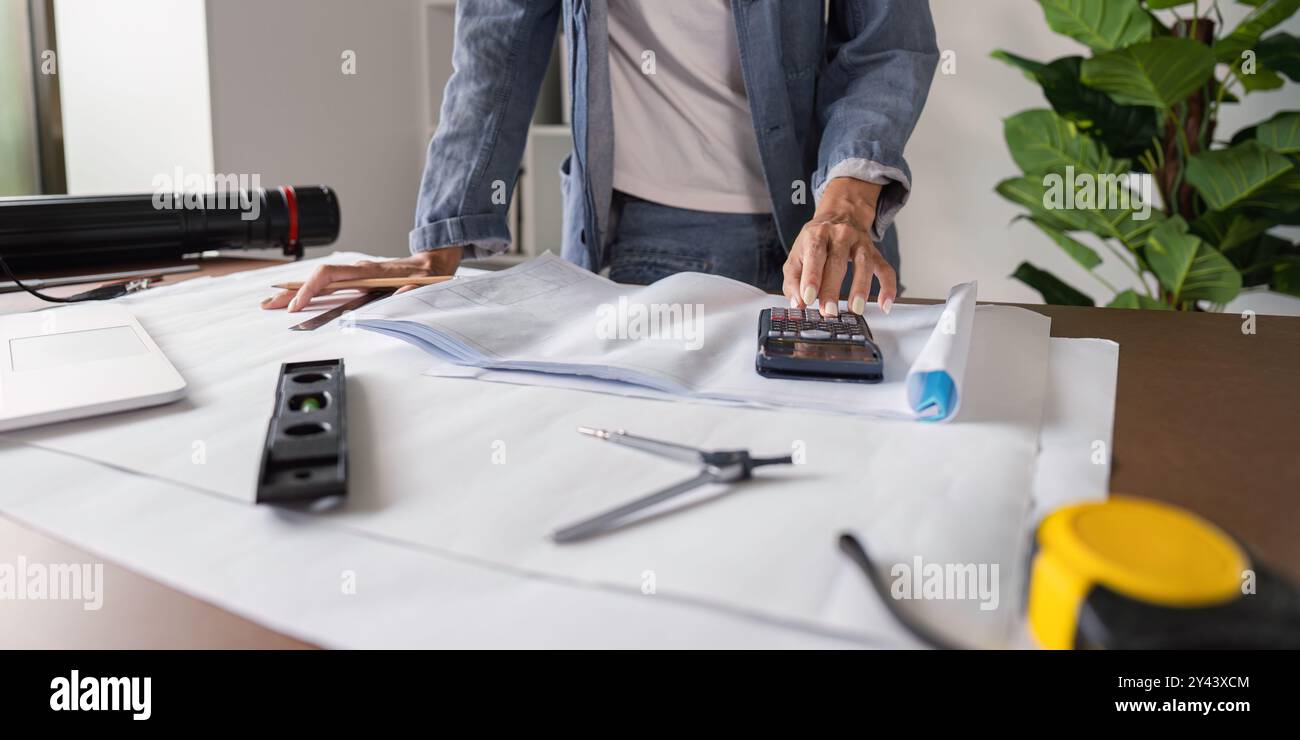 Architect Conducting Cost Calculations for Blueprint Planning in ...