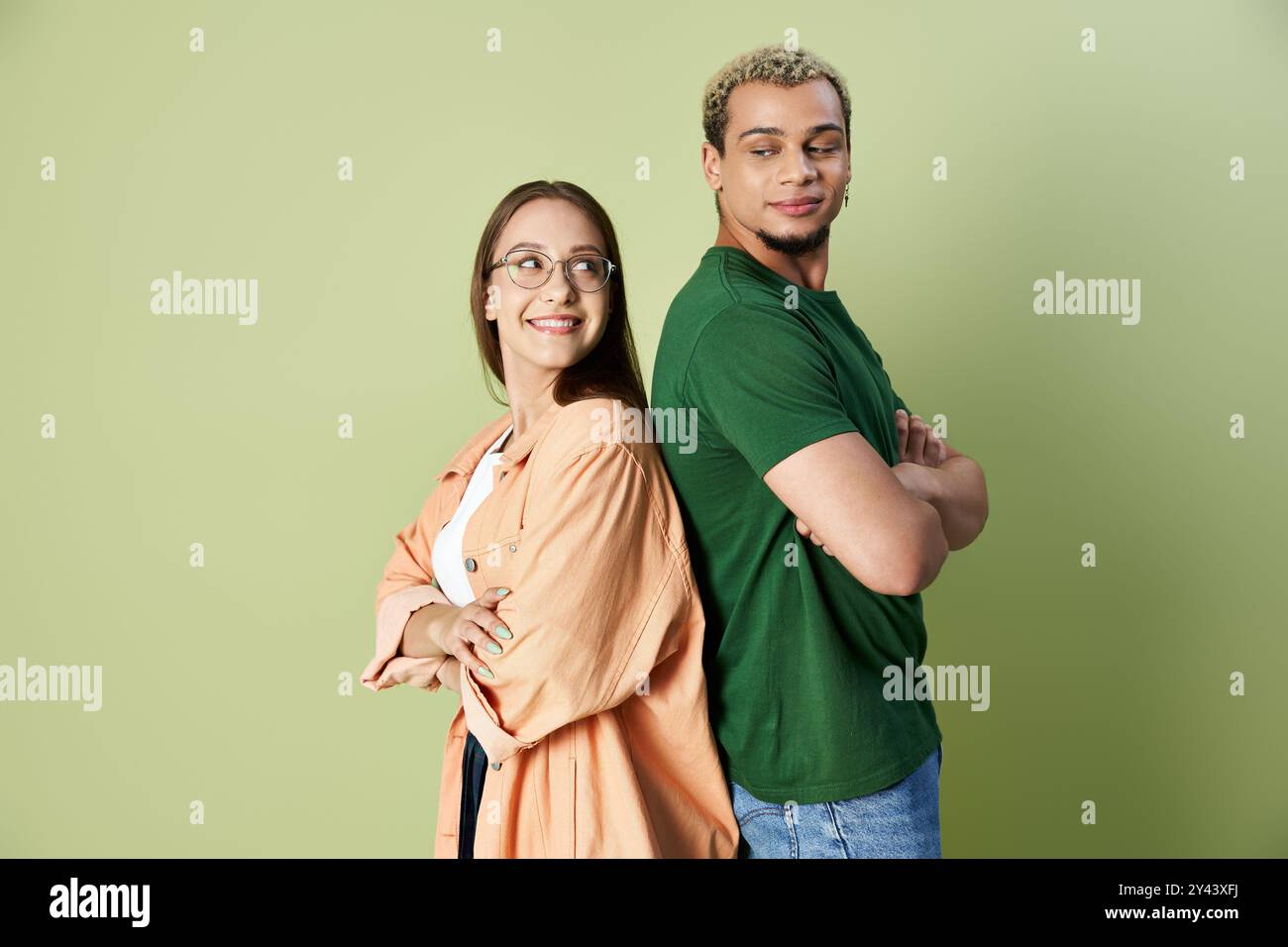 Two friends laugh and connect while standing back to back, enjoying ...