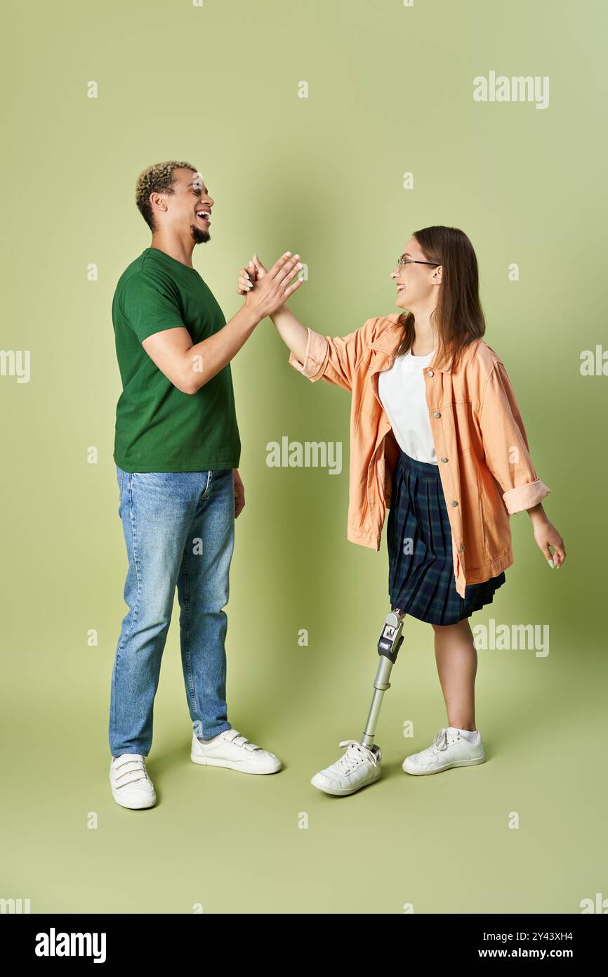 Two friends share a cheerful high five in a lively setting Stock Photo ...